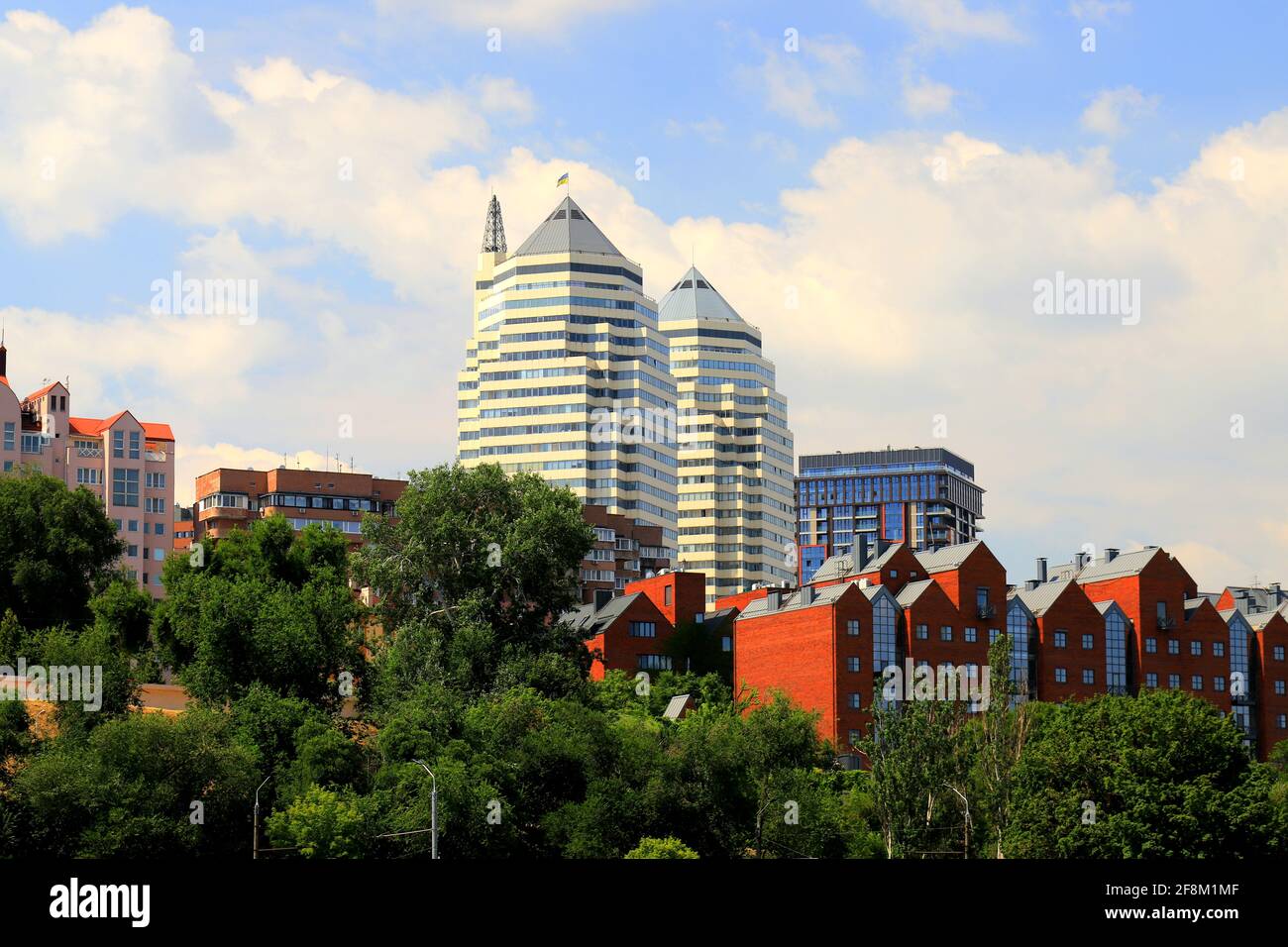 Beautiful tall white towers, skyscrapers, red buildings, park against ...