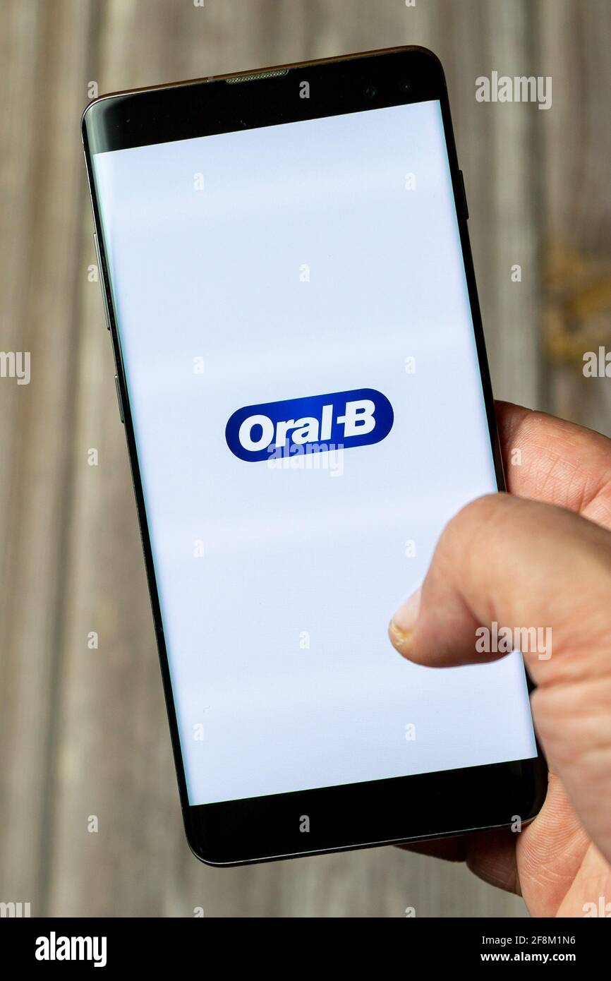 A Mobile phone or Cell phone being held in a hand showing the Oral B ...