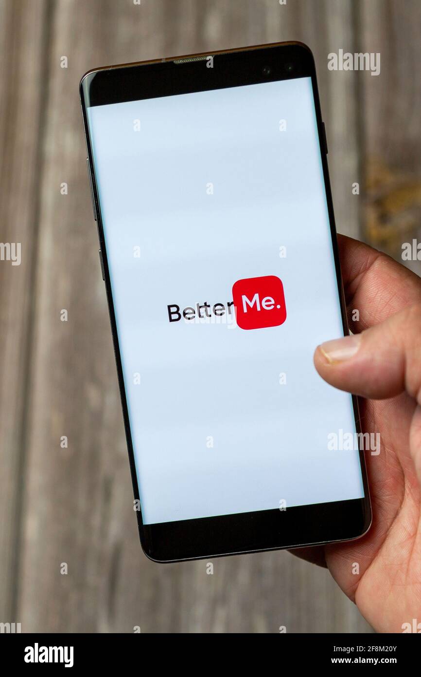 A Mobile phone or Cell phone being held in a hand showing the Better me ...