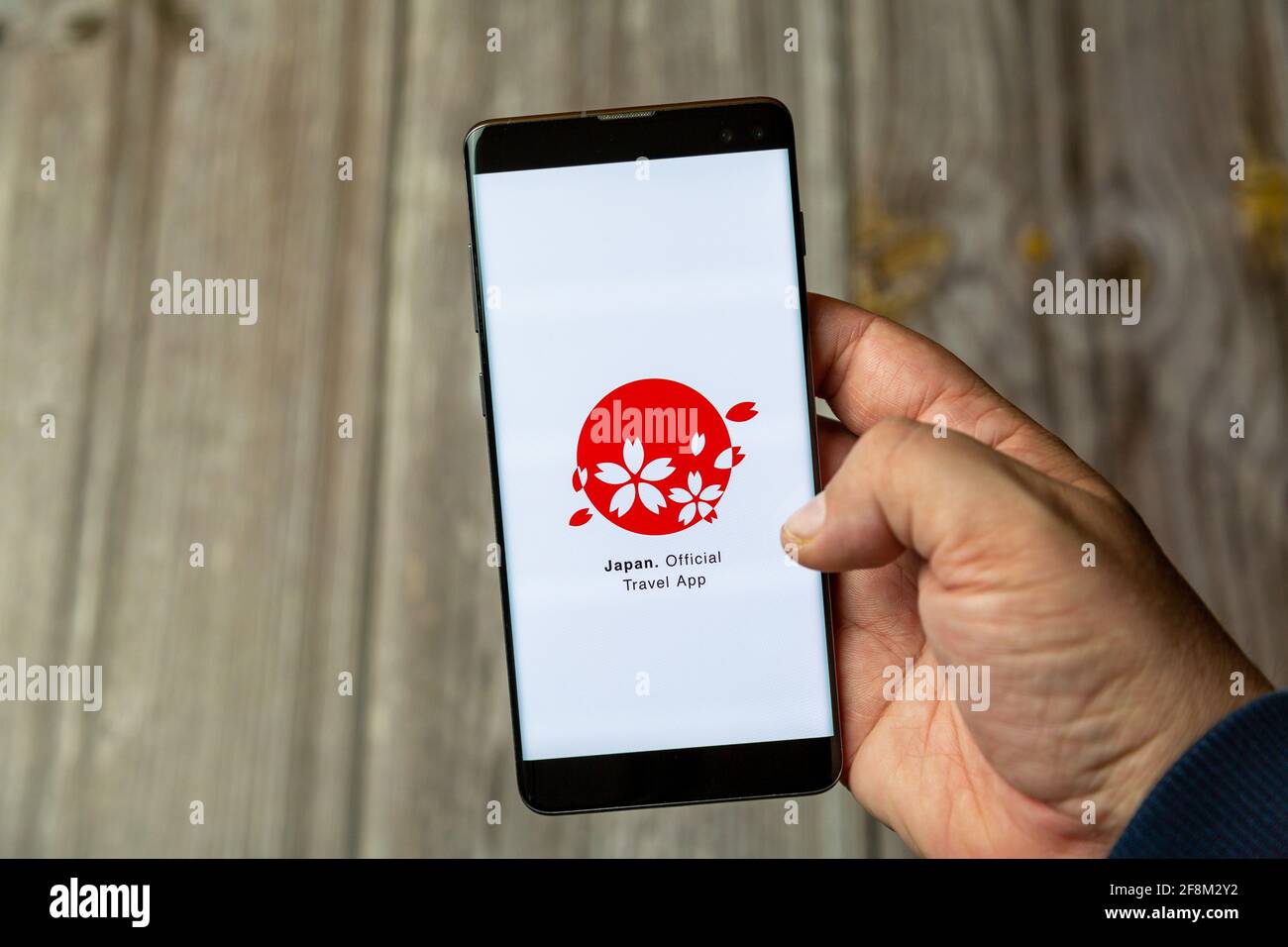 A Mobile phone or Cell phone being held in a hand showing the japan ...