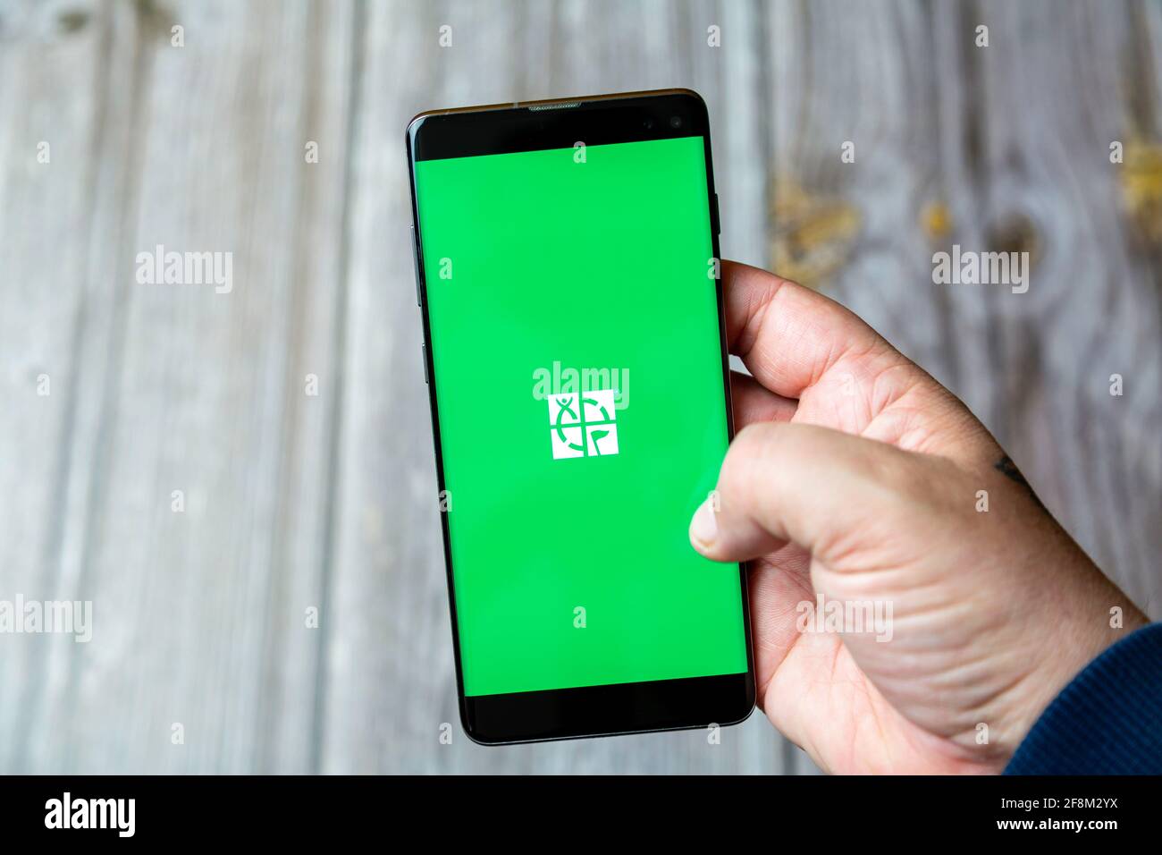 A Mobile phone or Cell phone being held in a hand showing the ...