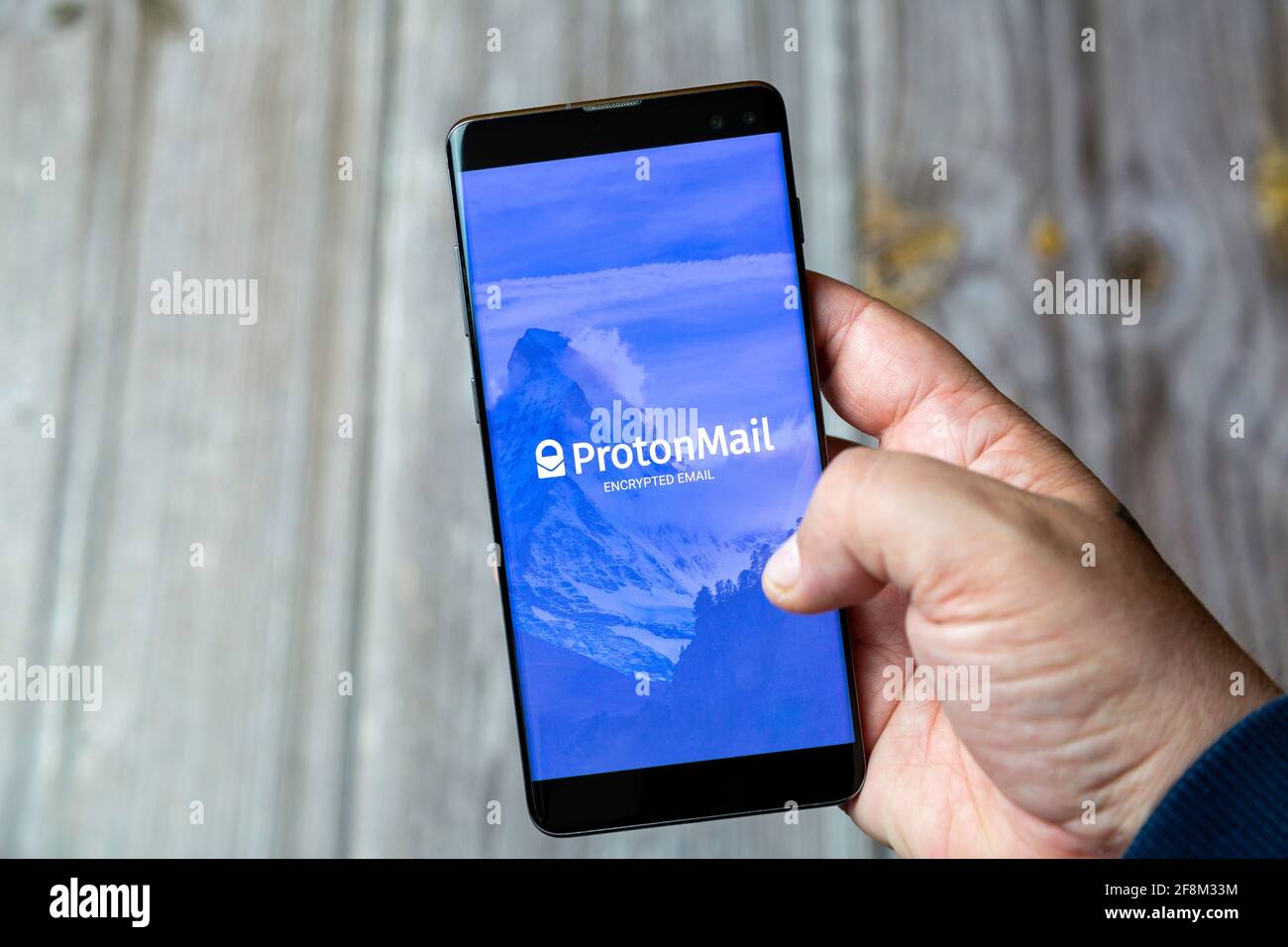 A Mobile phone or Cell phone being held in a hand showing the proton ...