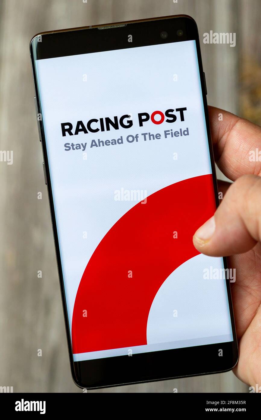 A Mobile phone or Cell phone being held in a hand showing the racing ...