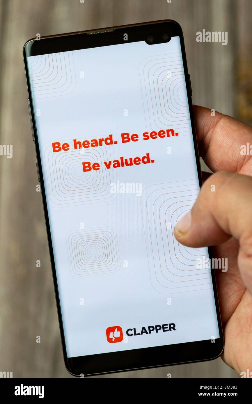 A Mobile phone or Cell phone being held in a hand showing the Clapper ...