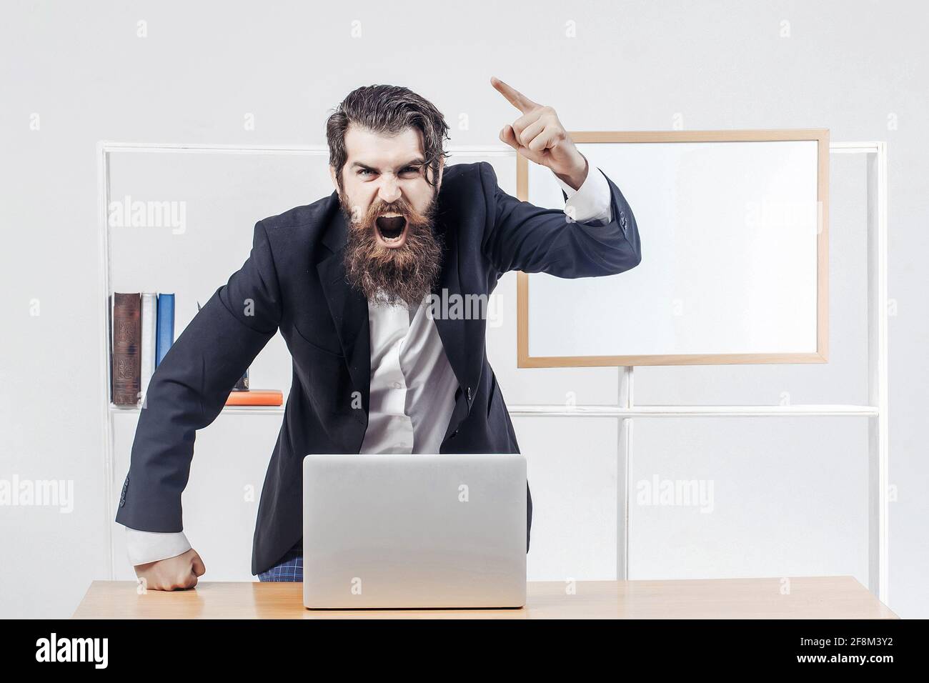 Angry teacher or professor in black suit shouts raised his finger up ...