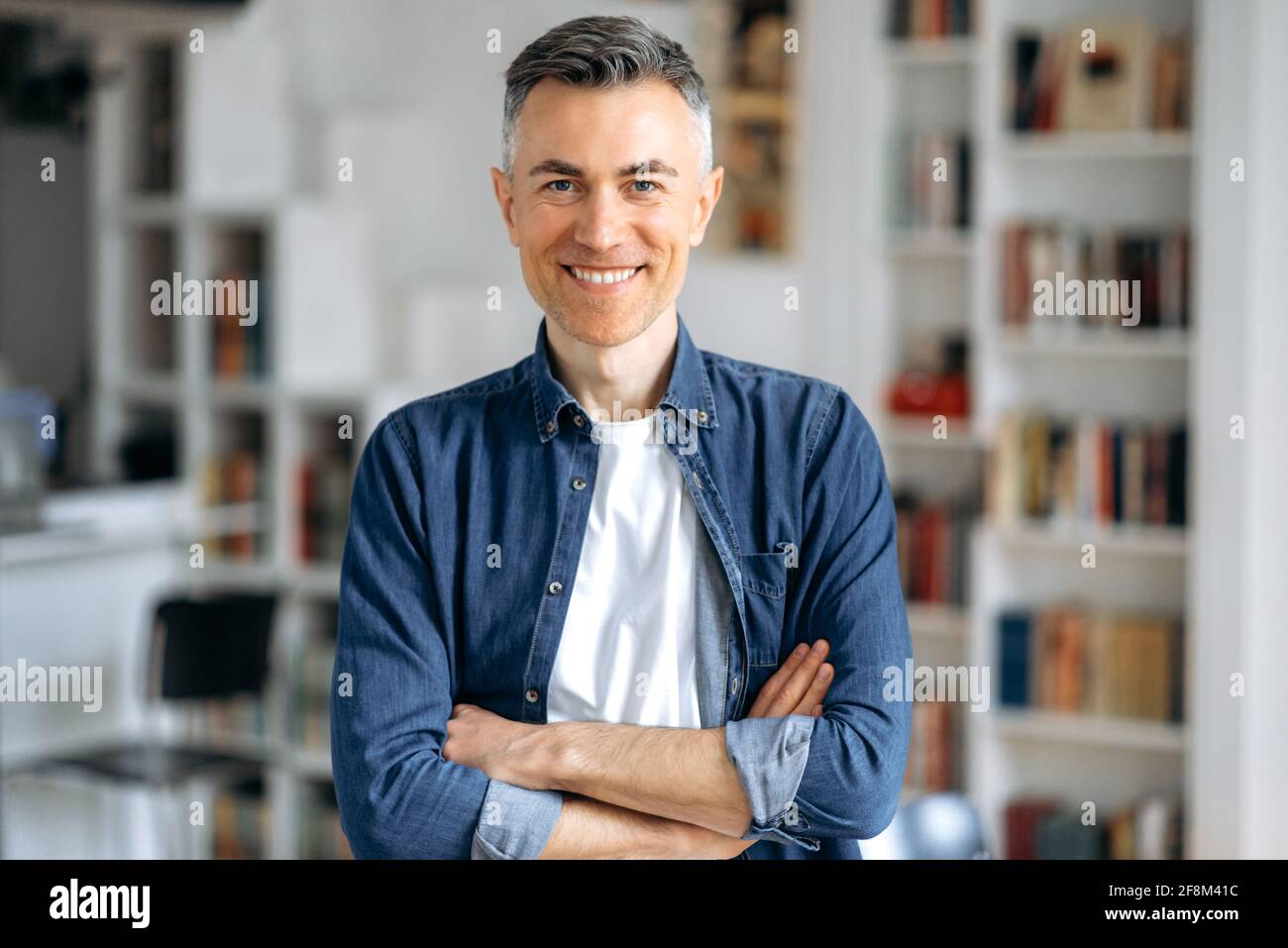 Portrait of an attractive mature gray haired caucasian man, freelancer ...