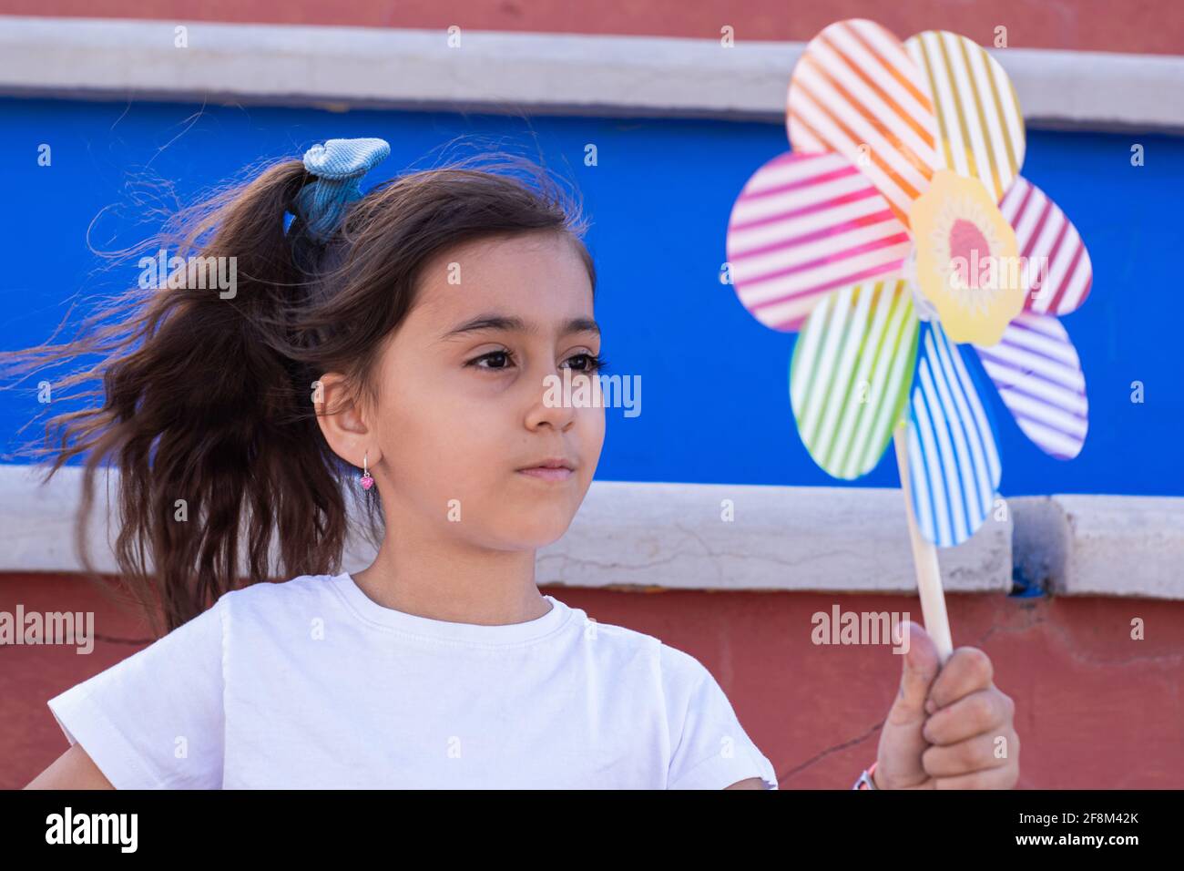 Girl with a pinwheel hi-res stock photography and images - Alamy