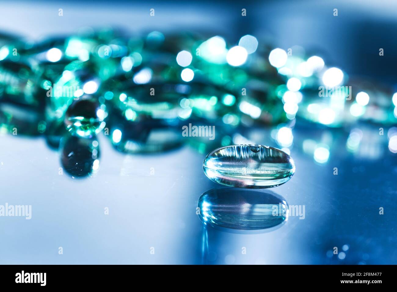 Shiny gel medication capsules on dark background Stock Photo - Alamy