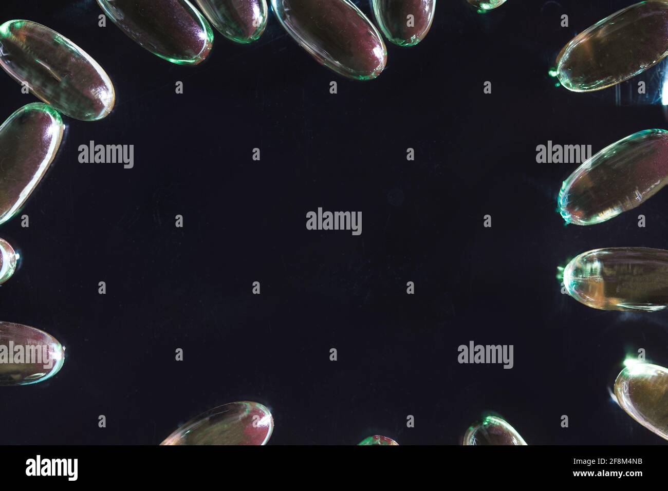 Shiny gel medication capsules on dark background Stock Photo - Alamy