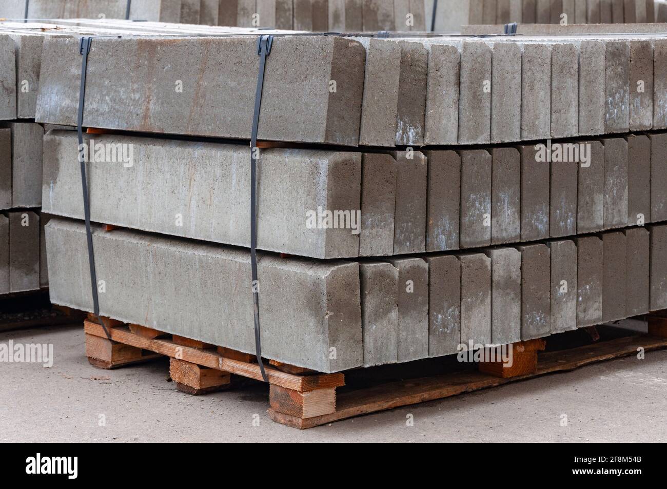 Pallet With A Stack Of Concrete Curb stone on construction site. Road ...