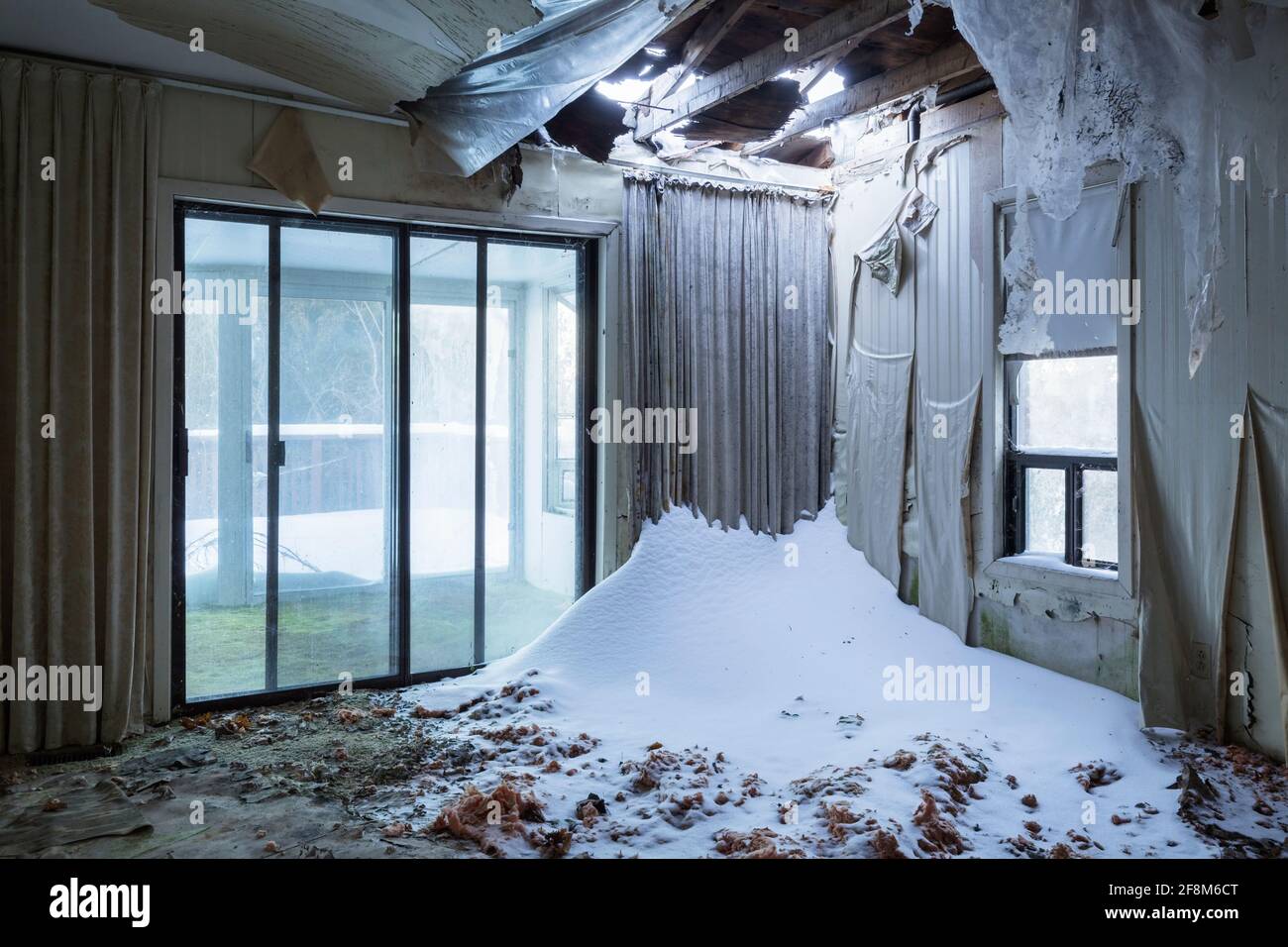 Snow that has collected beneath a collapsed ceiling inside a home Stock ...