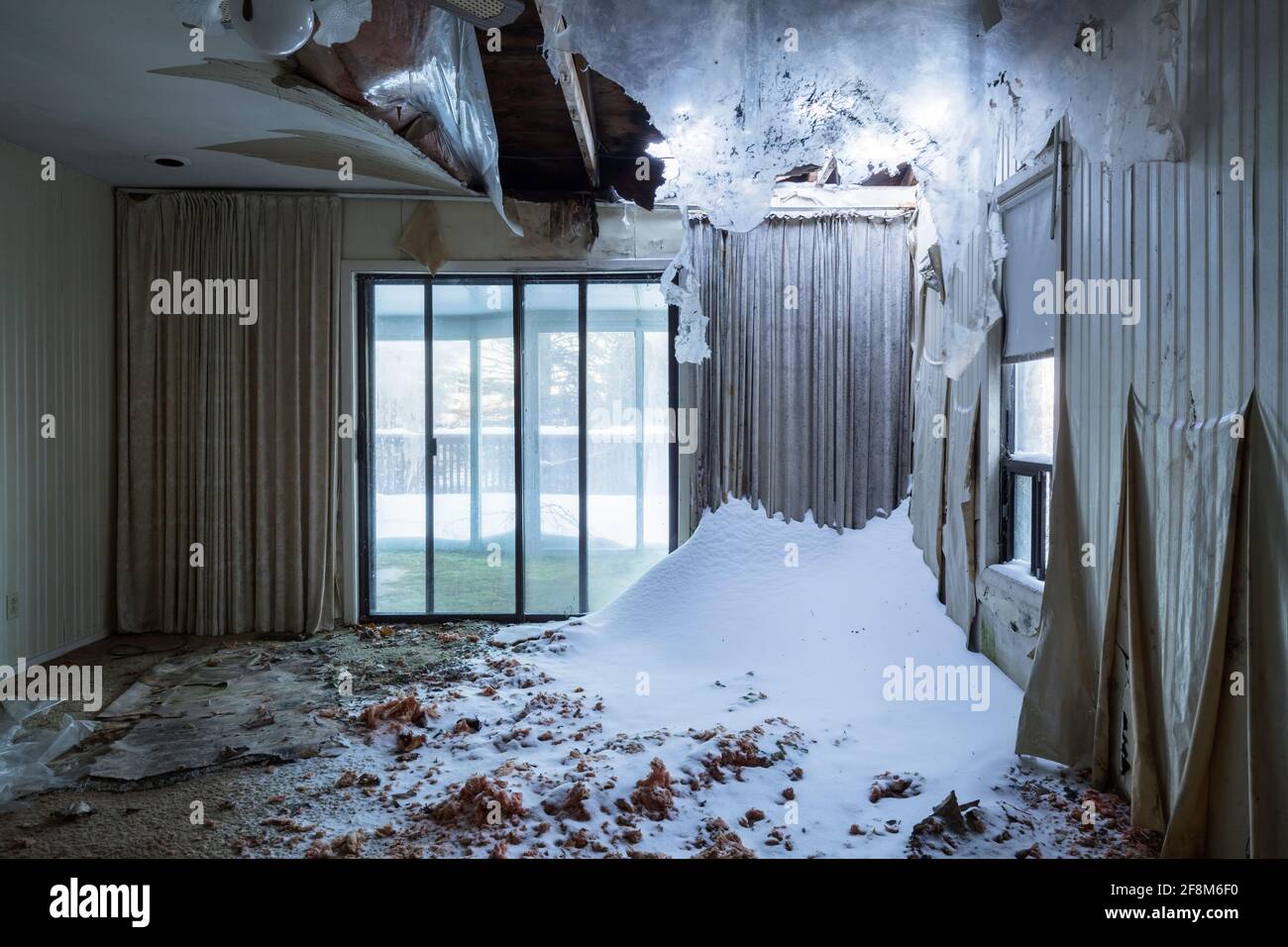 Snow that has collected beneath a collapsed ceiling inside a home Stock ...