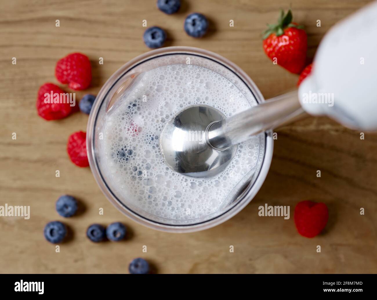 process of making fresh breakfast milkshake on wooden kitchen table ...