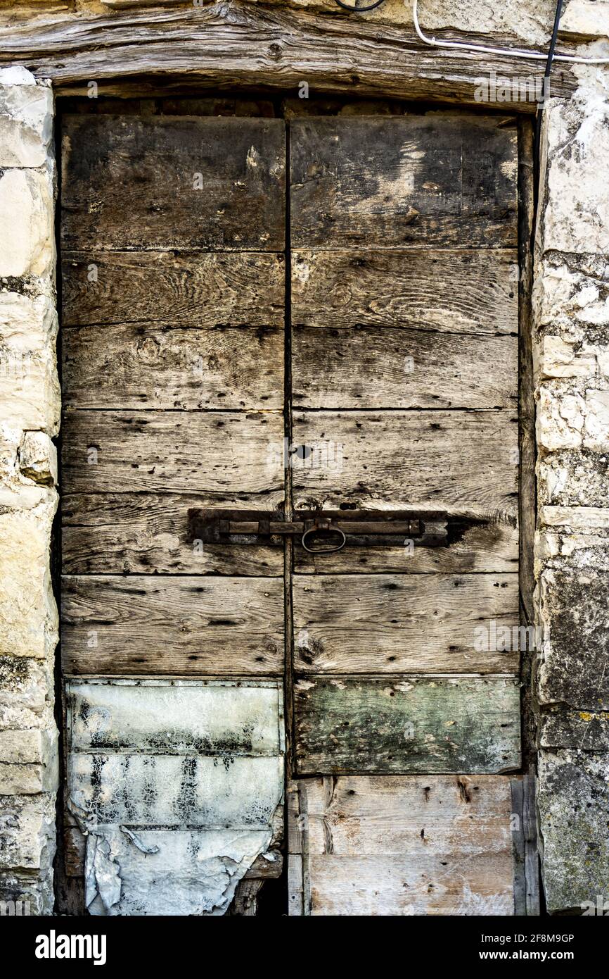 Vertical shot of an old wooden door with a metal lock Stock Photo - Alamy