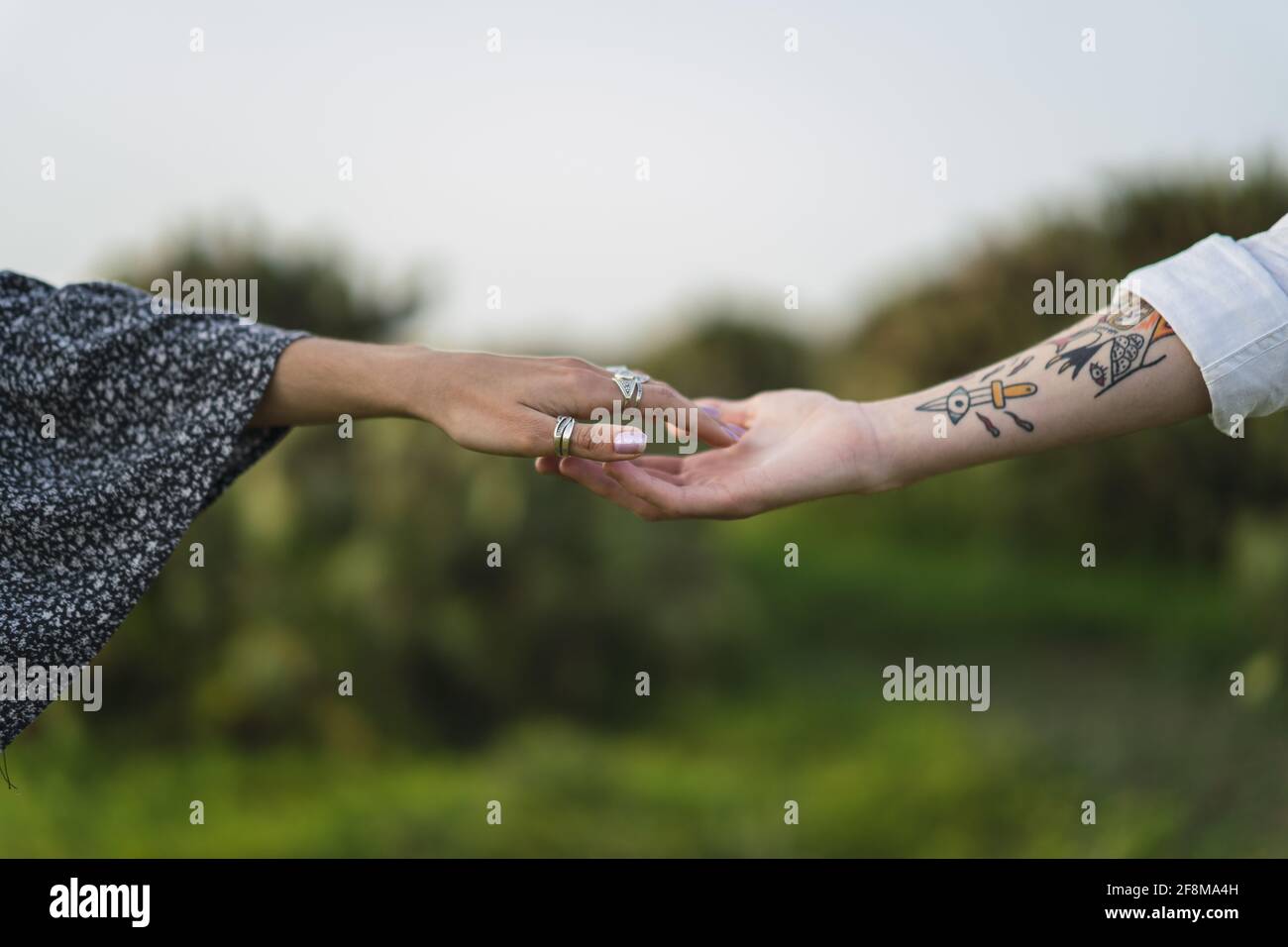 Shallow focus shot of two hands touching each other gently Stock Photo ...