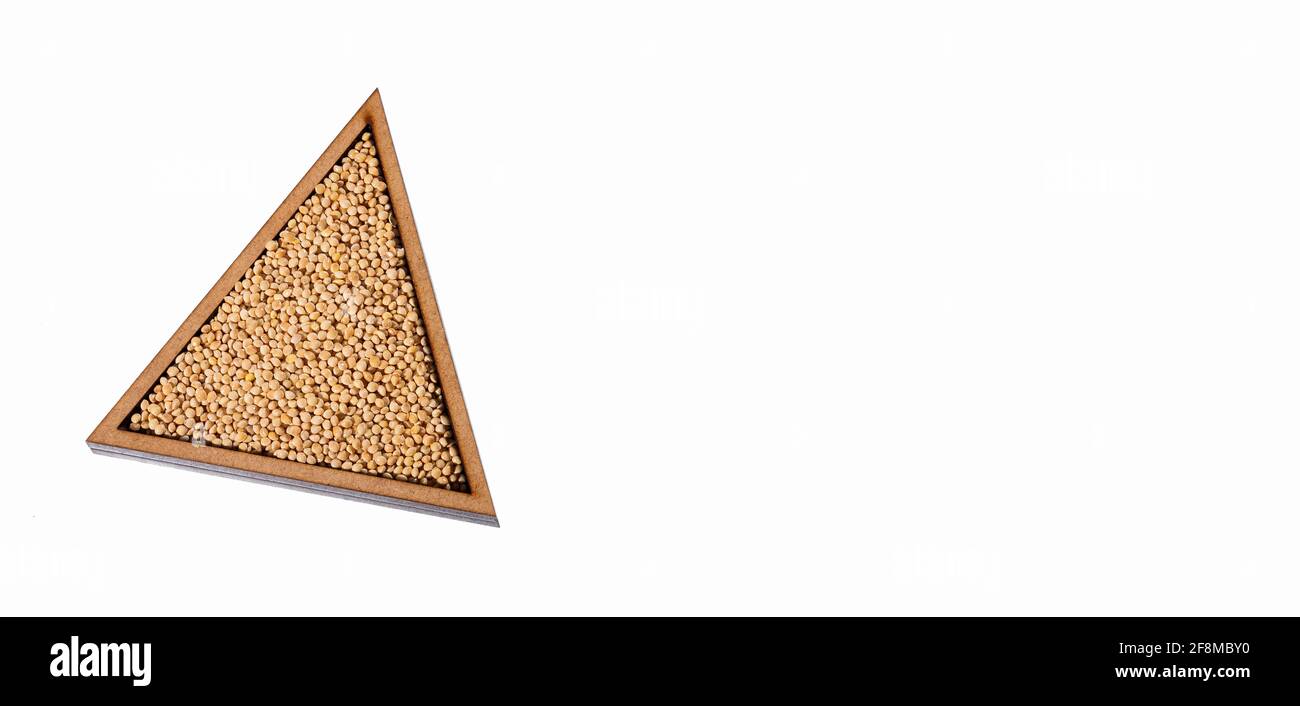 Healthy millet seeds in triangle bowl - healthy cereal Stock Photo - Alamy