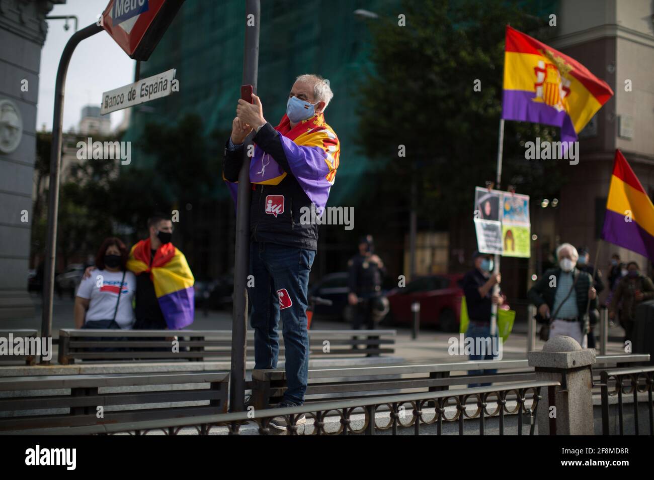 Madrid, Spain. 14th Apr, 2021. A man with a Republican flag on his back ...