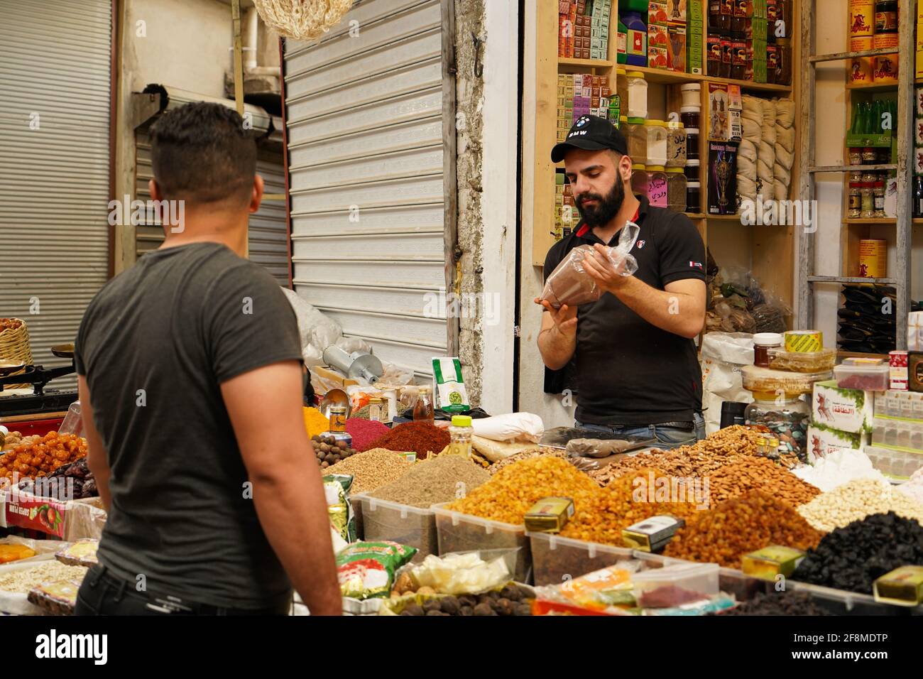 A customer seen buying spices from a seller in Bab Al-Saray market ...