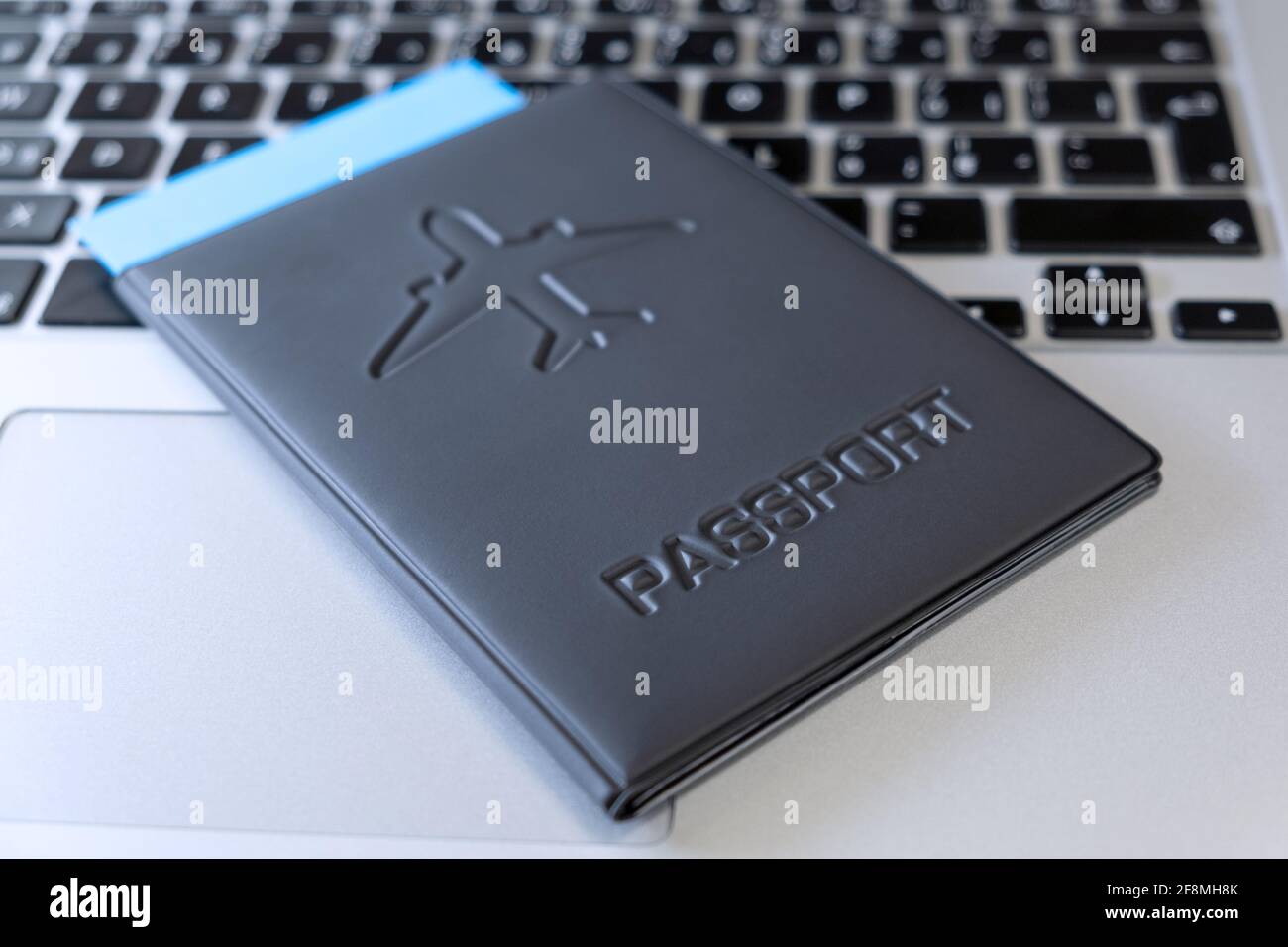 Passport on a laptop On Computer Keyboard . Planning a trip, buying ...