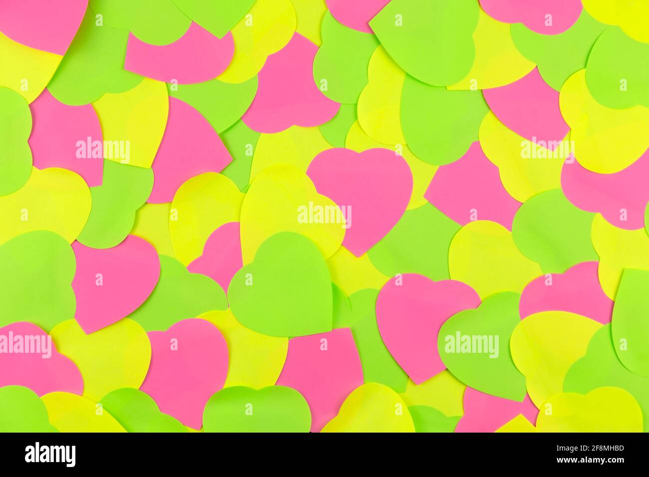 Closeup to Neon sticky notes in heart form shape. Love in Valentine's ...