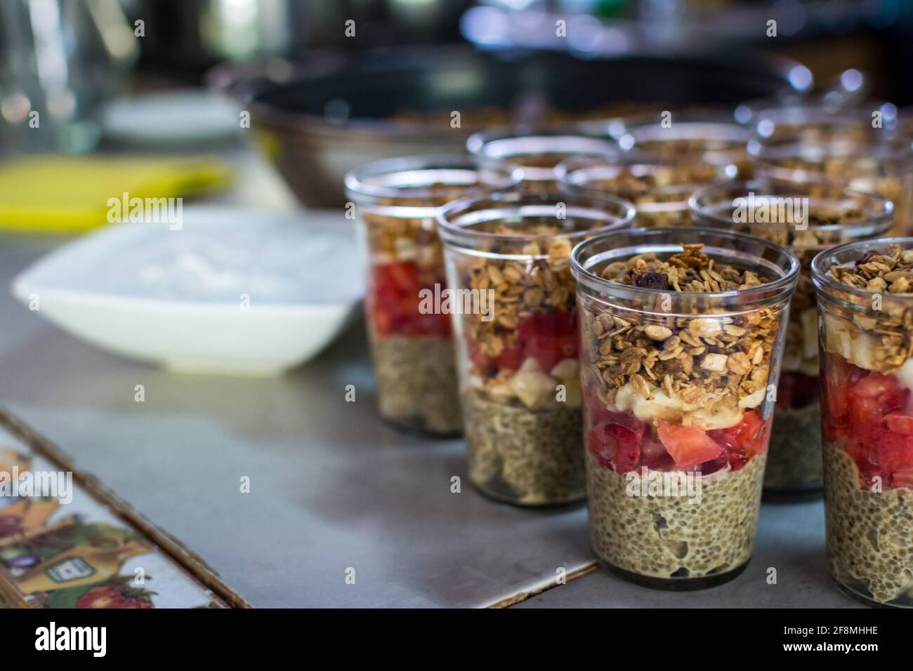 Closeup view of various transparent glasses filled with muesli, cream ...