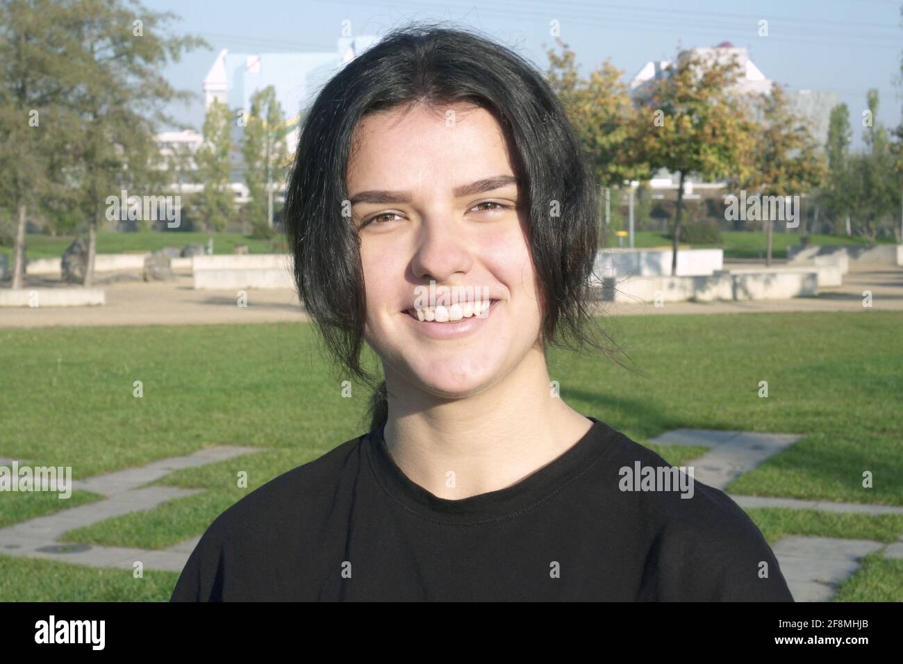 Caucasian teenager In City park Smile Happy Face. Talking youmg Woman ...