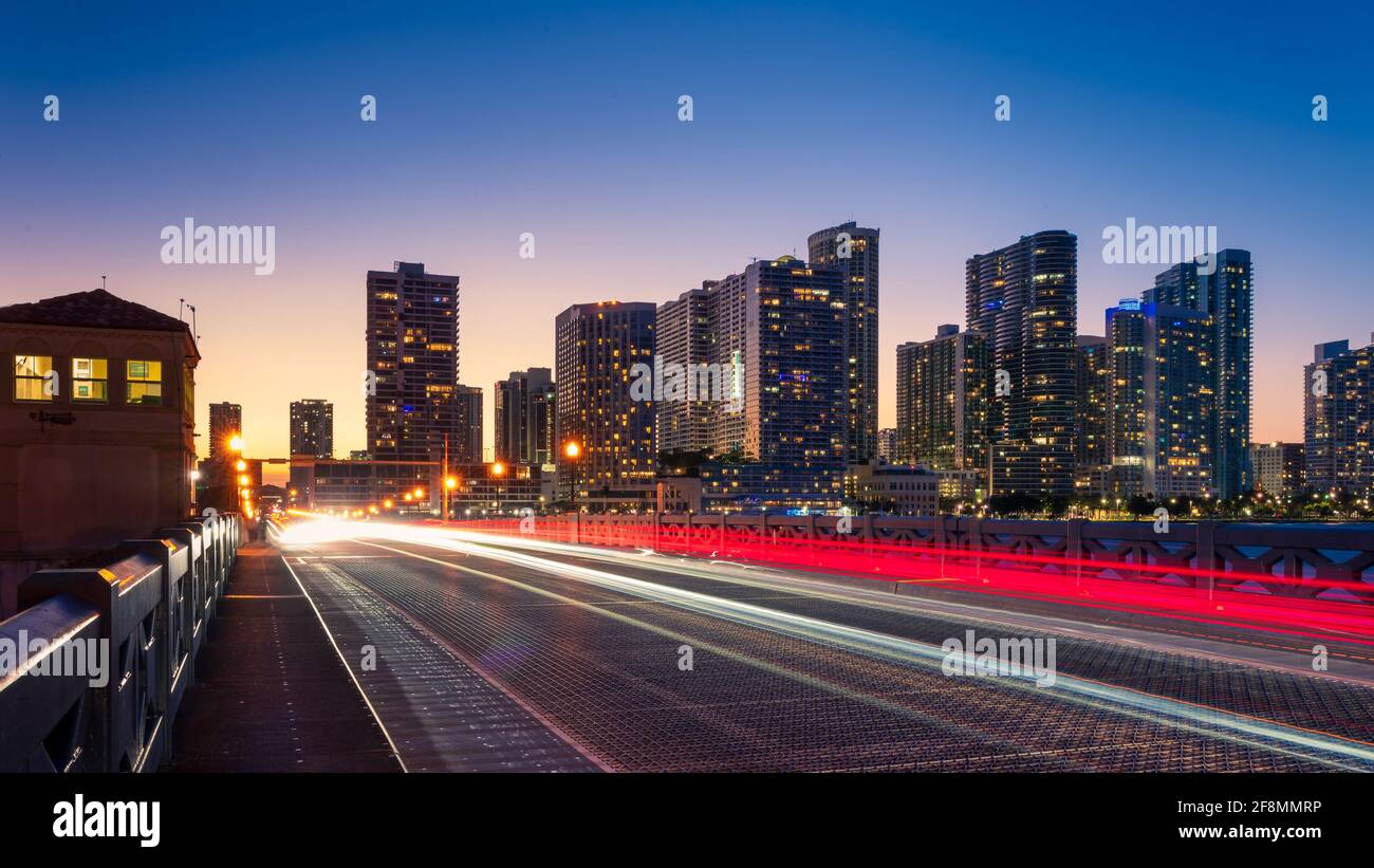 Miami city skyline with moving traffic light trails at night on ...