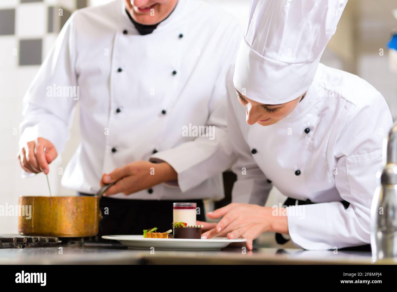 Chef team in restaurant kitchen with dessert working together Stock ...