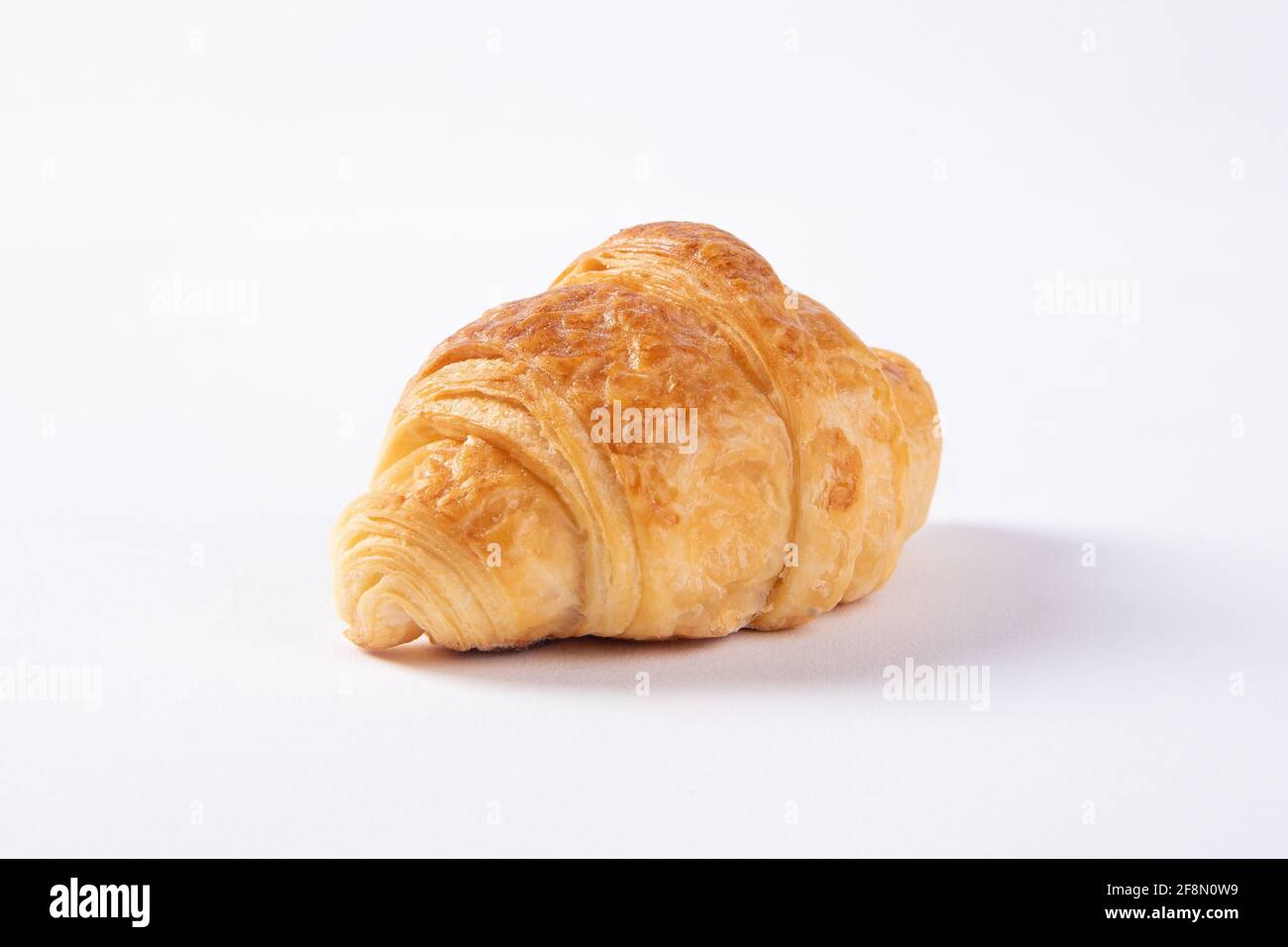 Closeup of a fresh croissant isolated on a white background Stock Photo ...