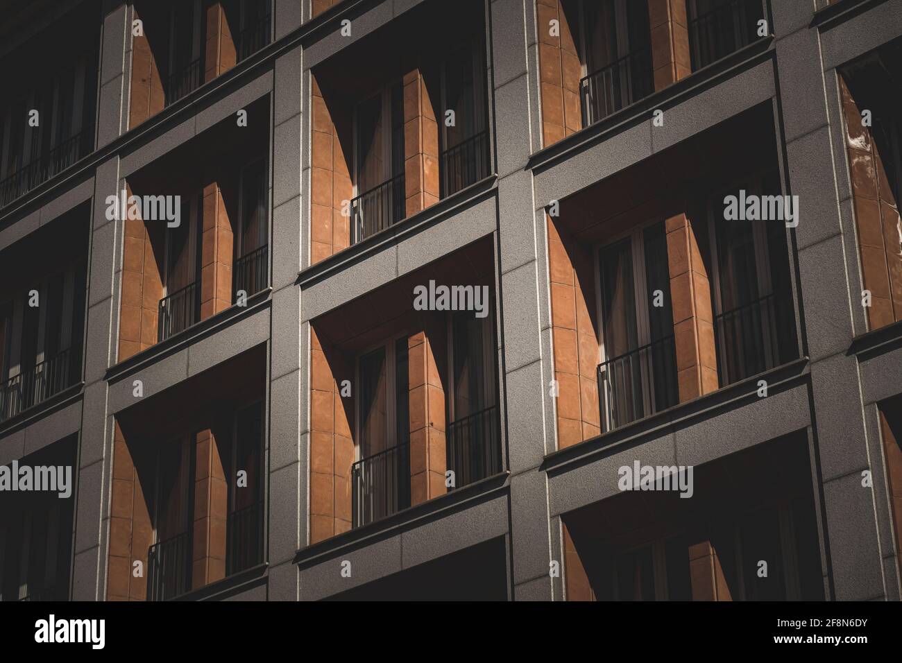 Building facade with windows and sunlight falling on it Stock Photo - Alamy