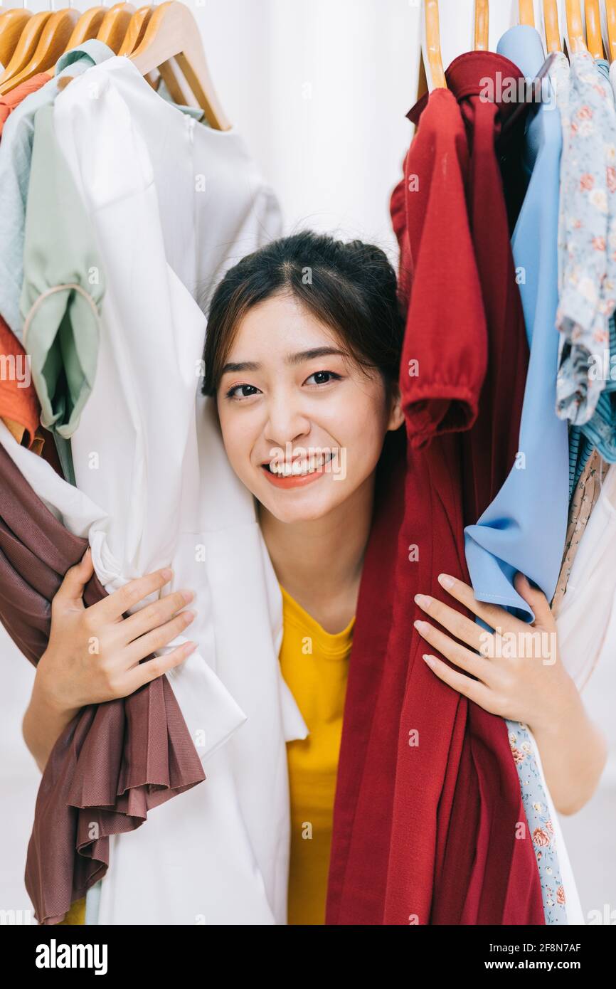 Asian girl stuck in her mess of clothes Stock Photo - Alamy