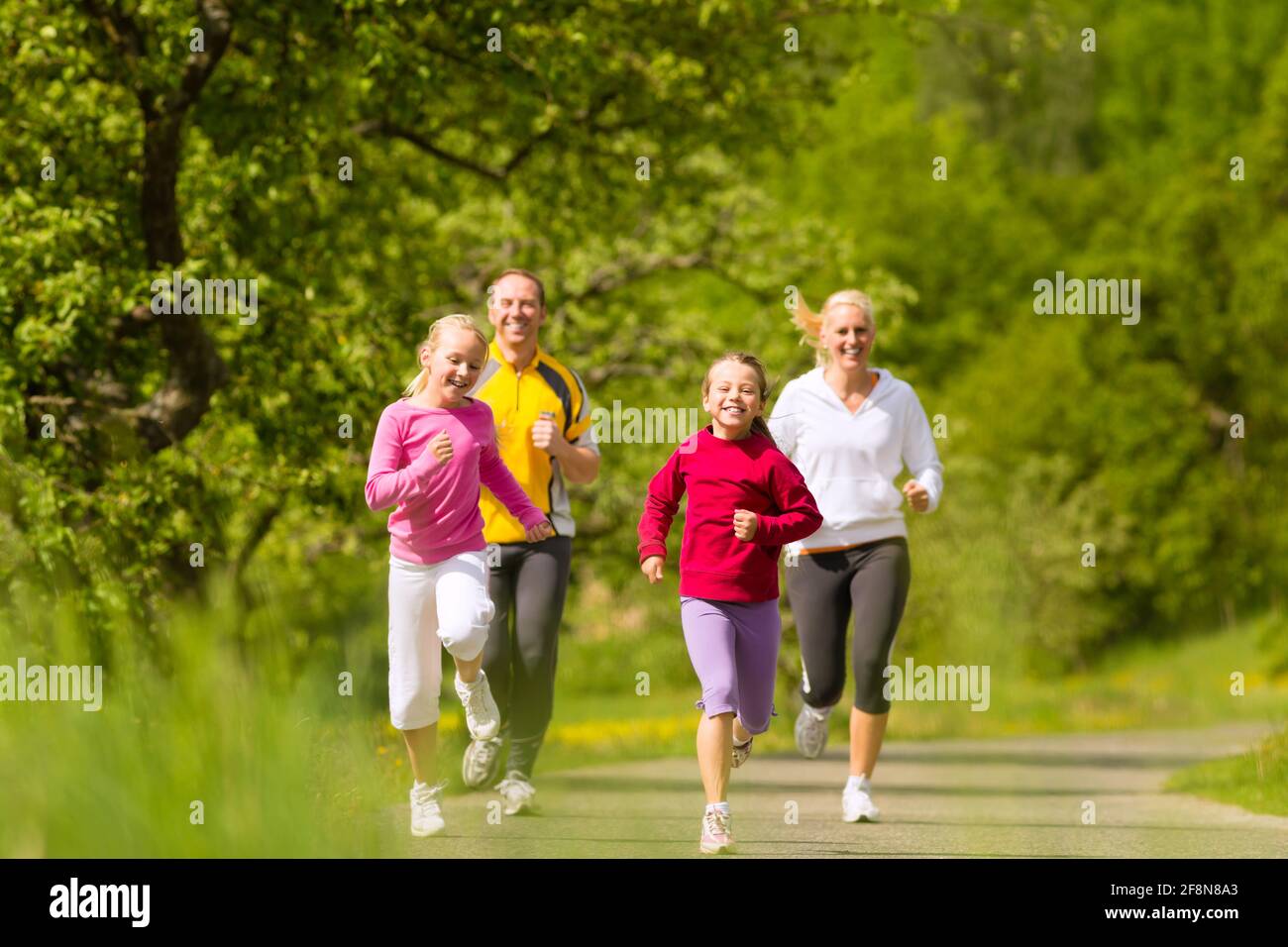 Family jogging for sport outdoors with the kids on summer day Stock ...