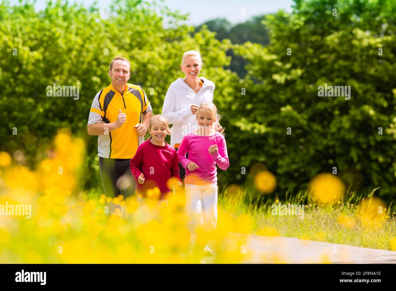 Family jogging for sport outdoors with the kids on summer day Stock ...