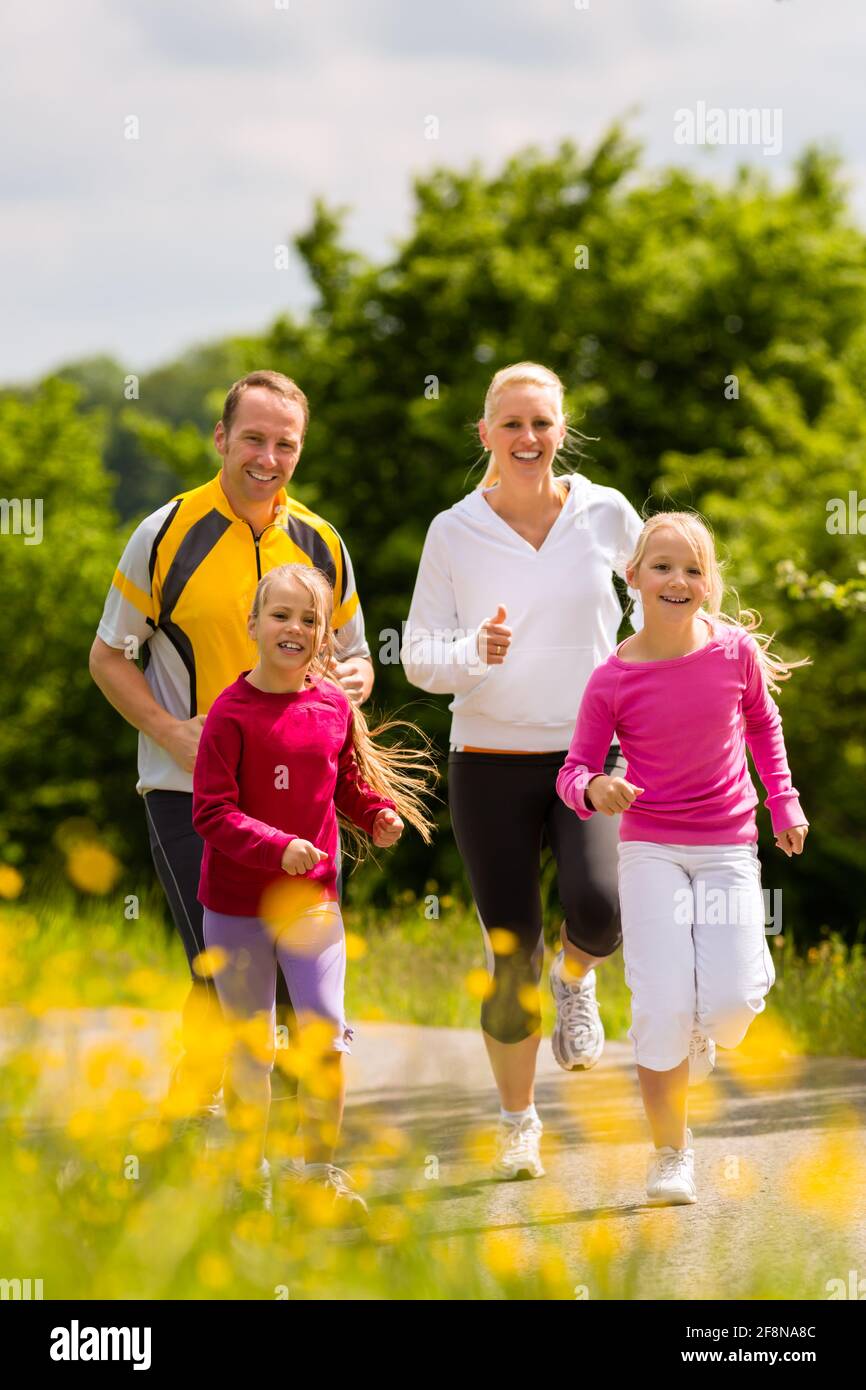 Family jogging for sport outdoors with the kids on summer day Stock ...