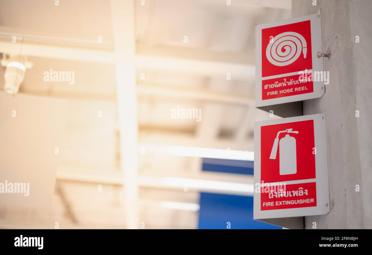 Red fire alarm sign on the white wall for safety first and sign for ...