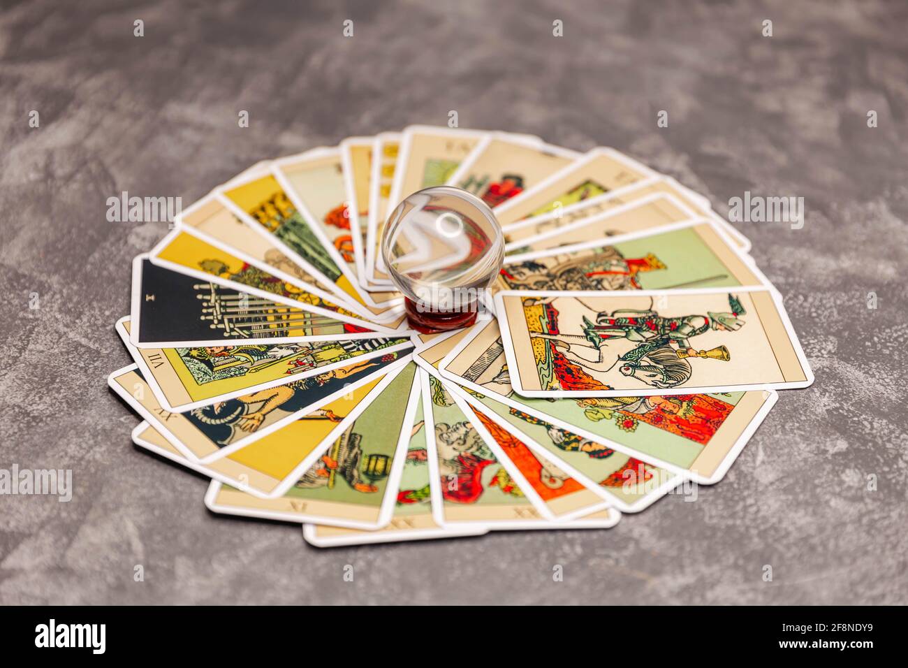 Reflection of tarot cards through magic ball on fortune teller desk ...