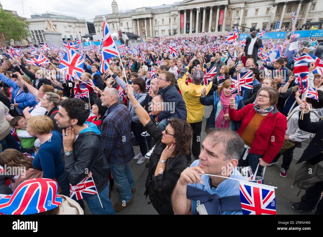 A large crowd of people gathered in Trafalgar Square to watch a giant ...