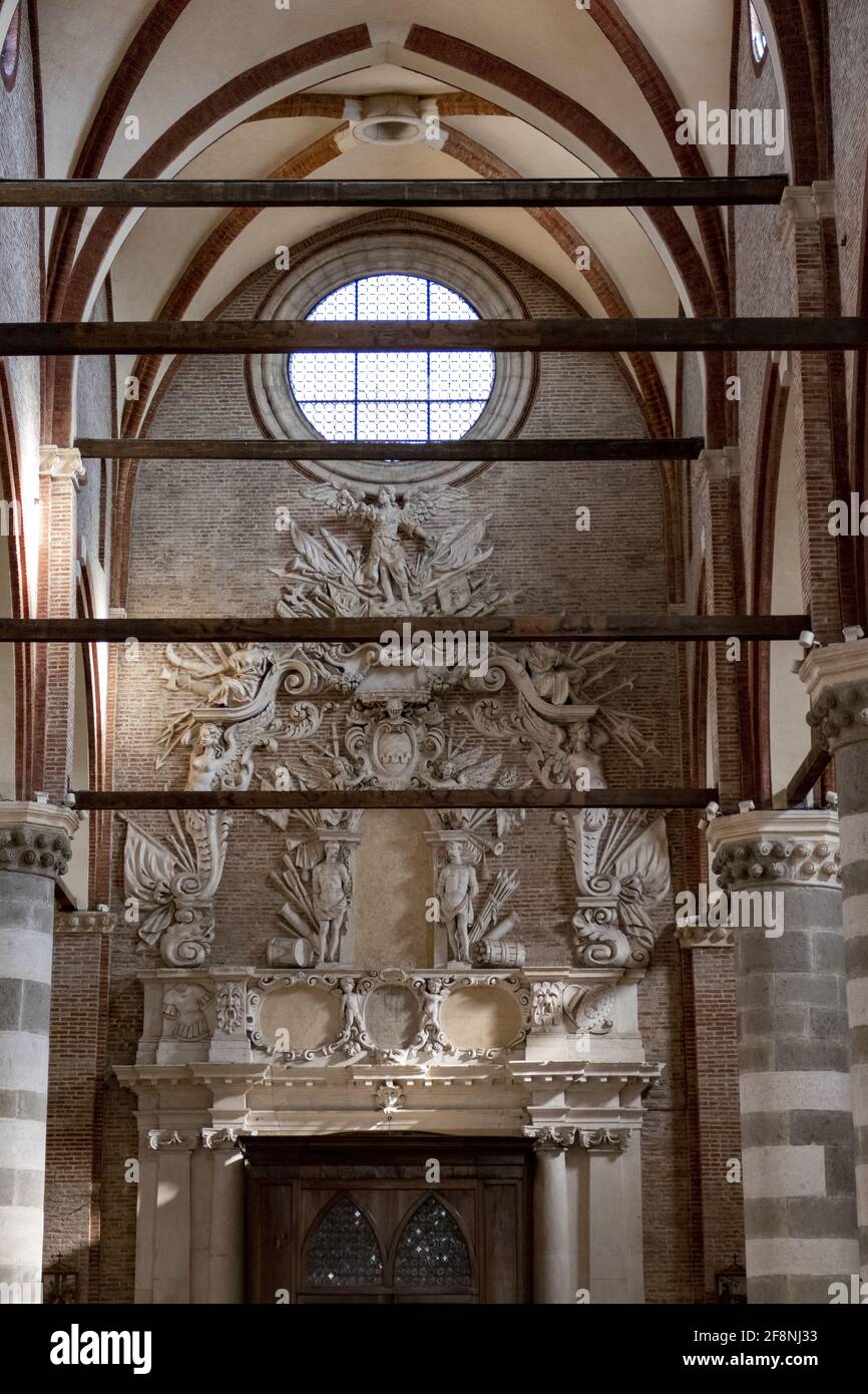 Vertical shot of a church interior with columns, arches and biblical ...