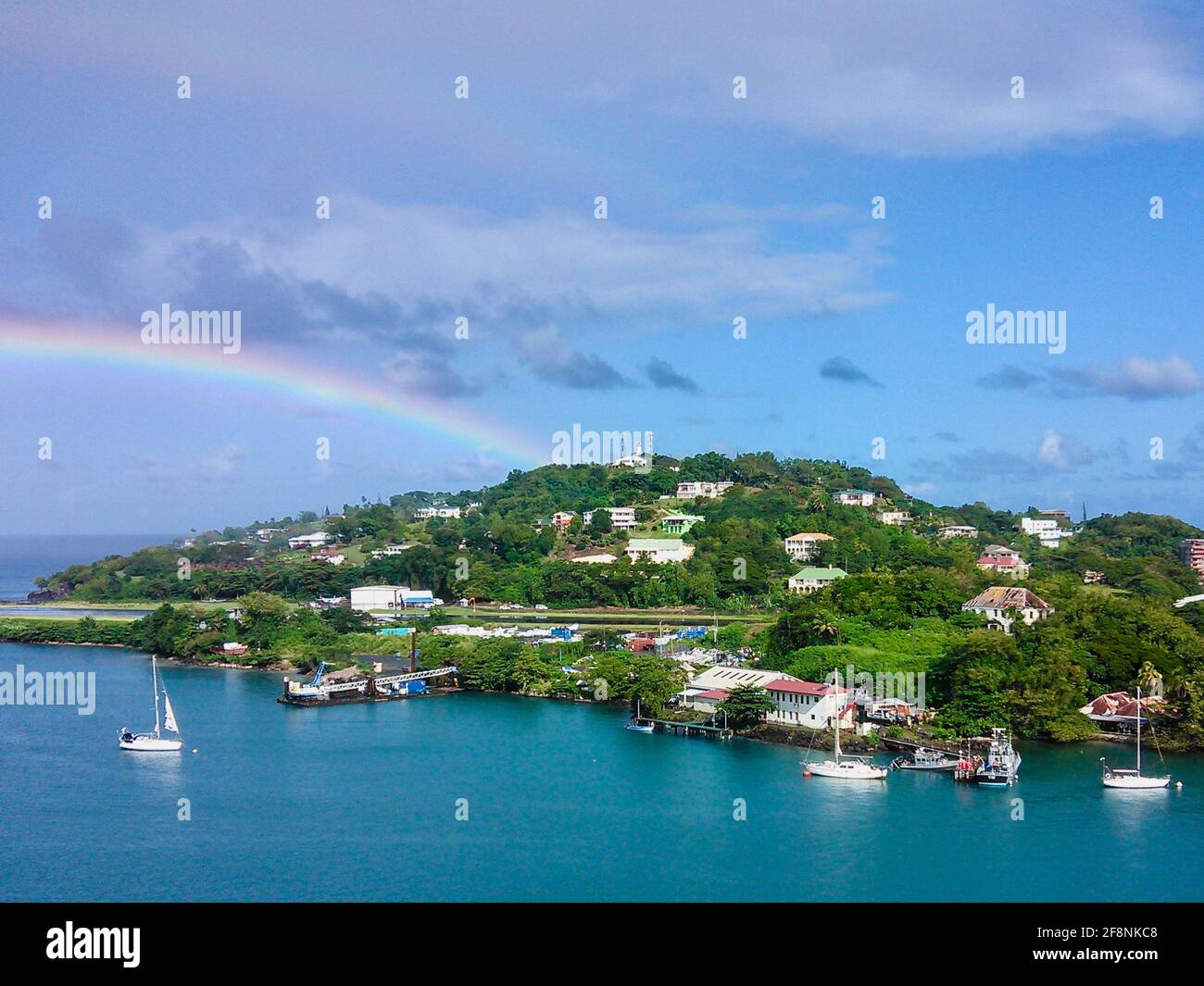 rainbow over a tropical island Stock Photo - Alamy