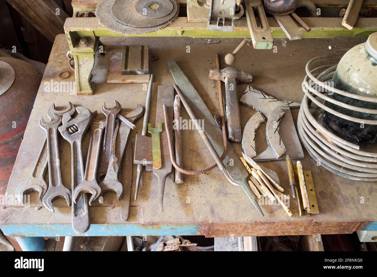 Old rusty work table with various tools. Photo can be used as a whole ...