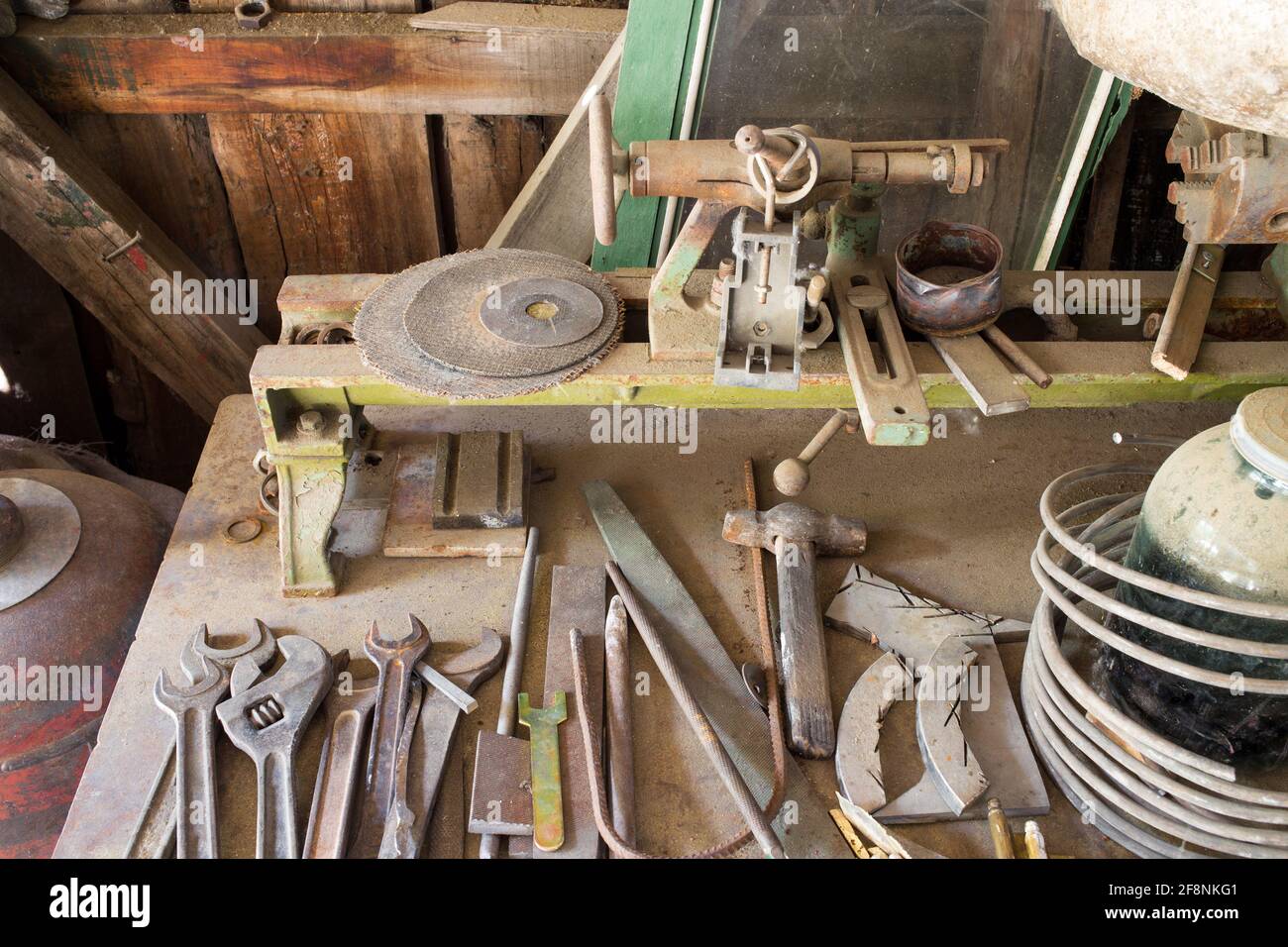 Old rusty work table with various tools. Photo can be used as a whole ...