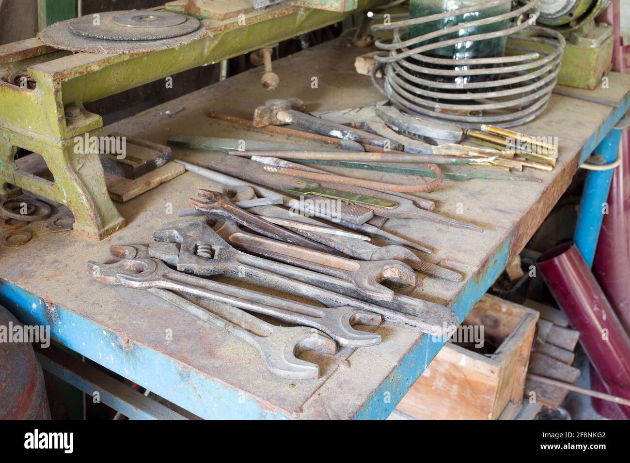 Old rusty work table with various tools. Photo can be used as a whole ...
