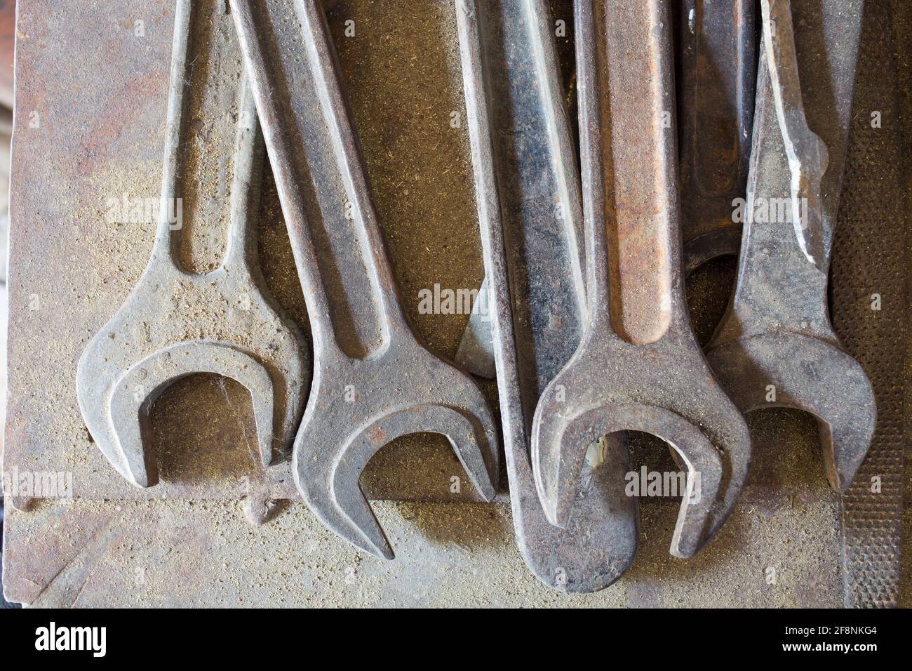 Group of old wrenches in different sizes on rusty metal table as a ...