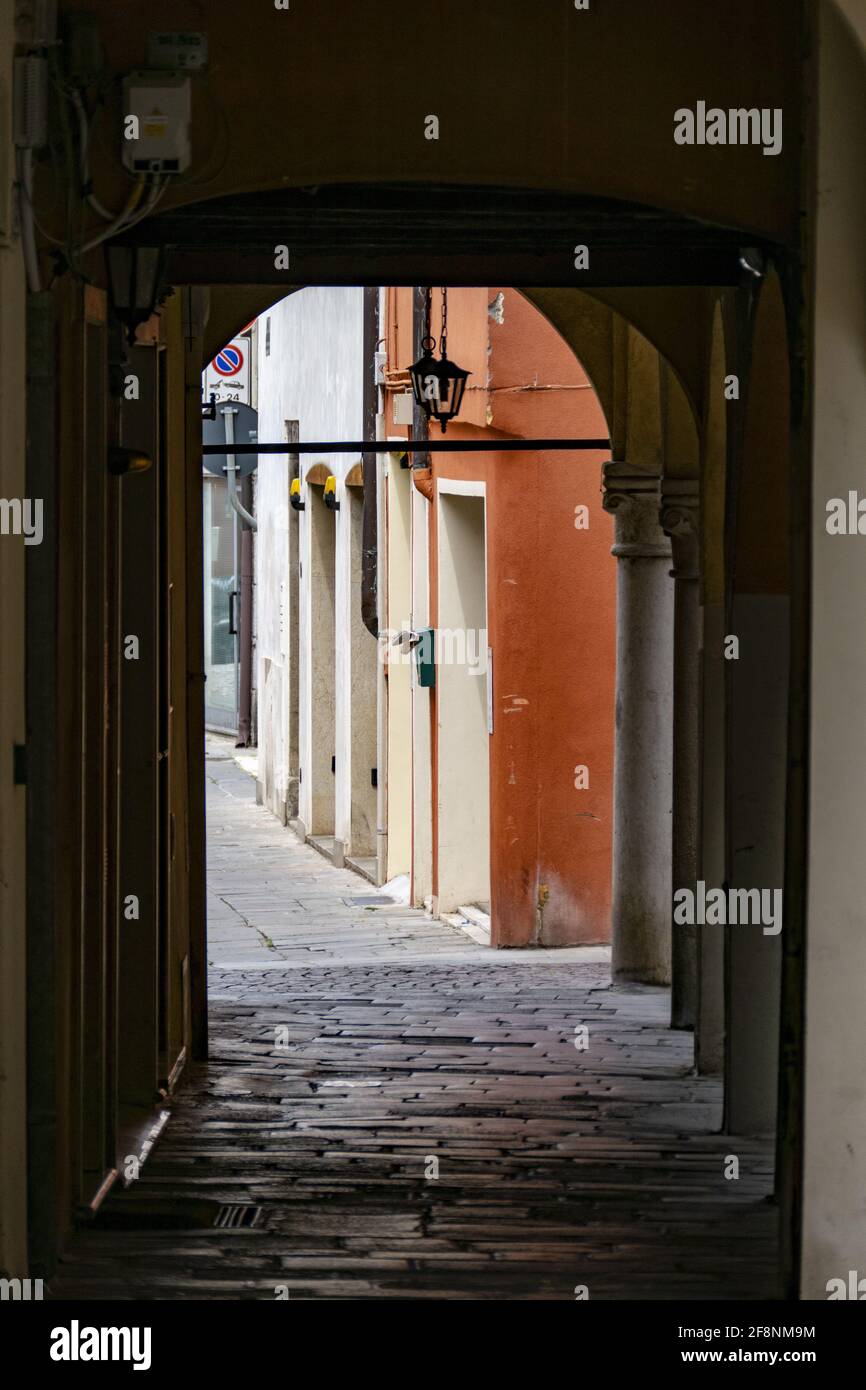 Vertical shot of a corridor with arches and columns in the background ...