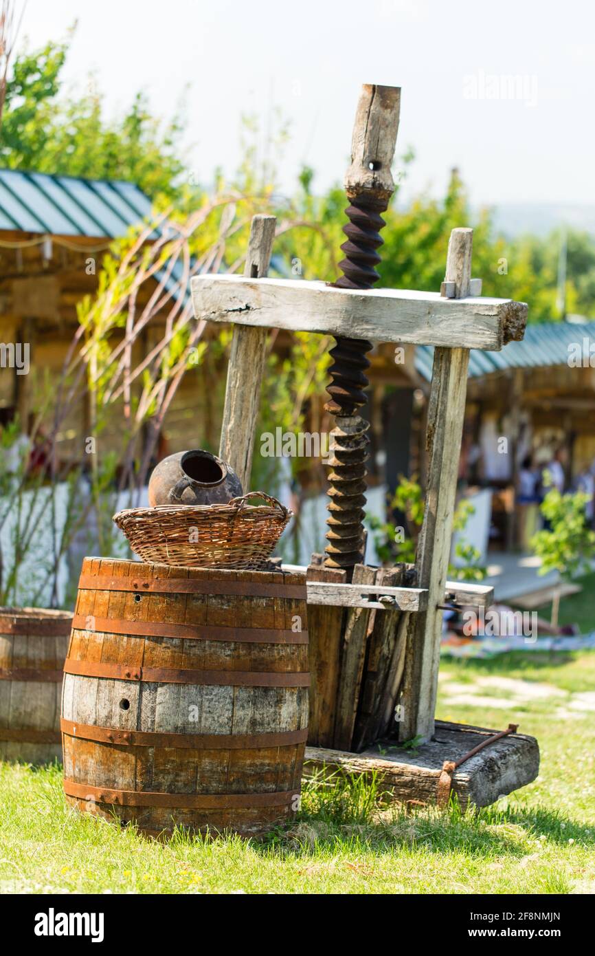 Old rusty wine press with oak barrel at the backyard Stock Photo - Alamy