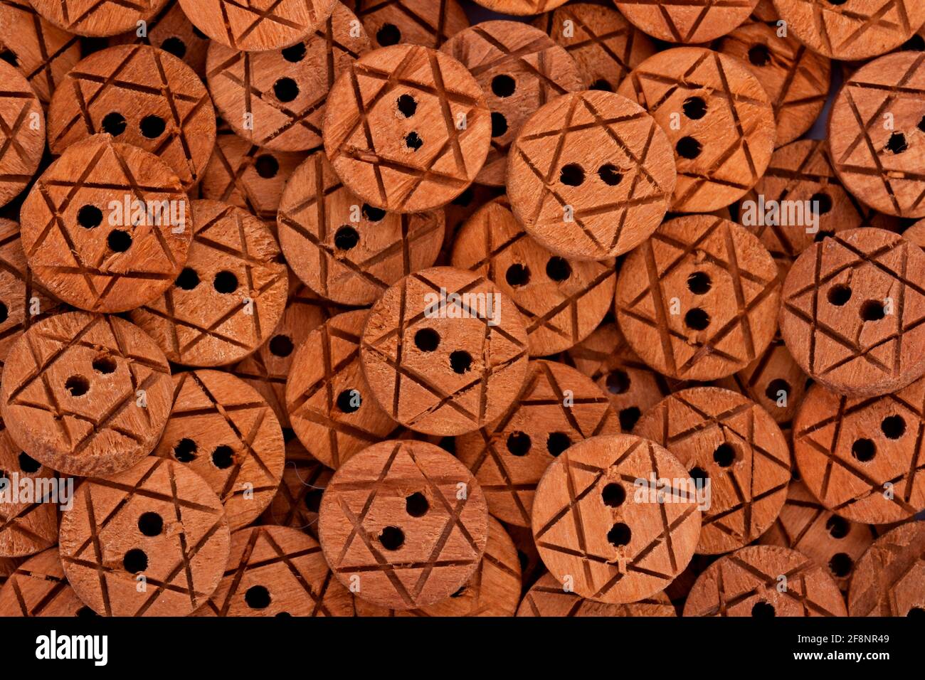 Wooden raw button close up background Stock Photo - Alamy