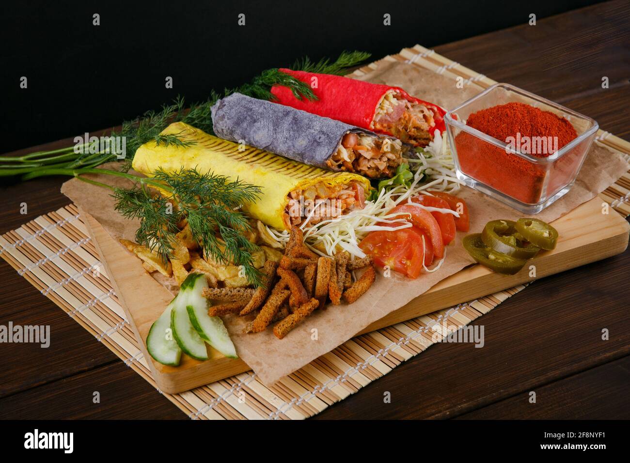 Fresh hot fragrant shawarma cut lies on a wooden board with vegetables ...