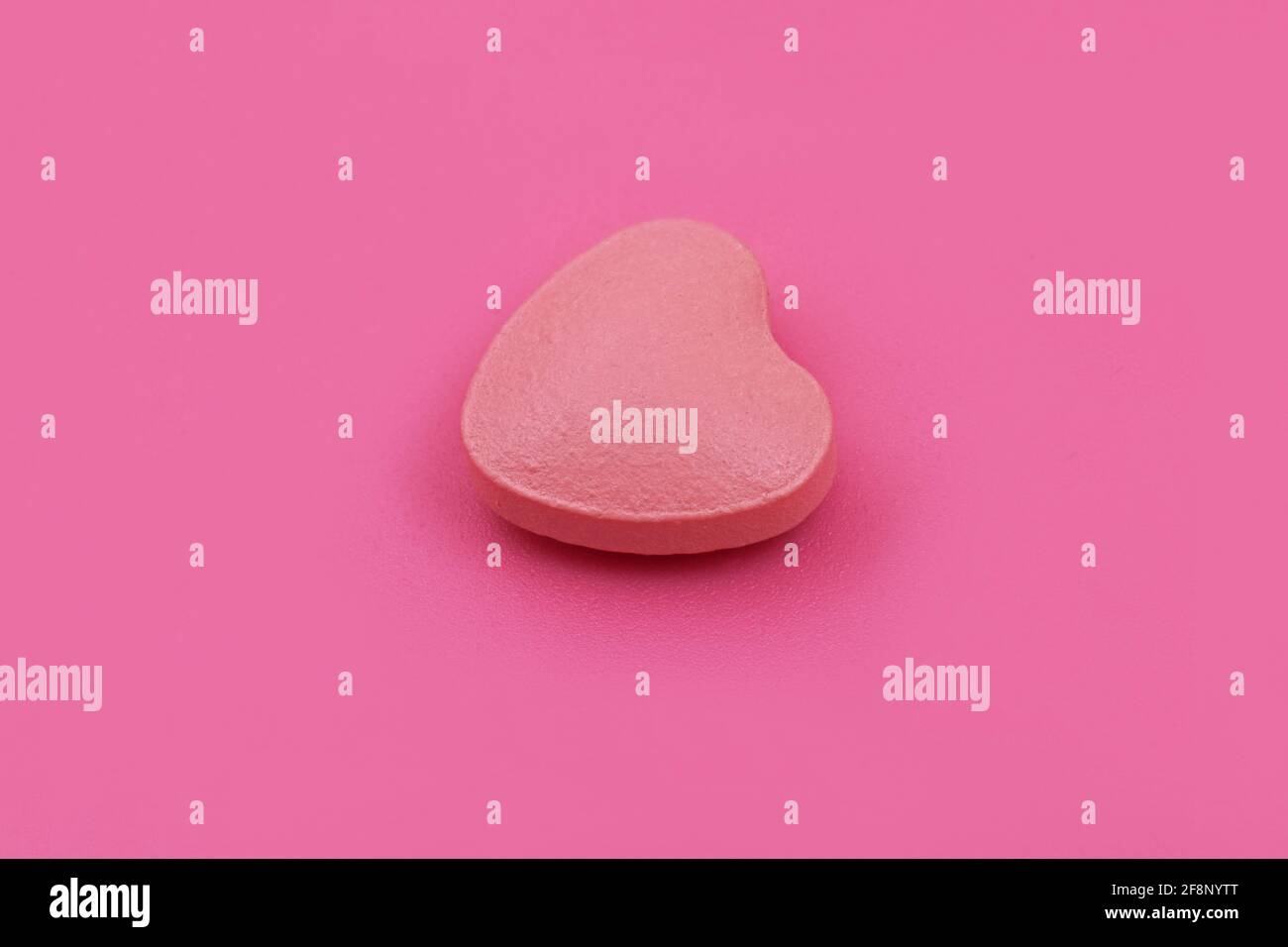 Heart shape Pharmaceutical medicine tablet on pink background, Flat lay ...