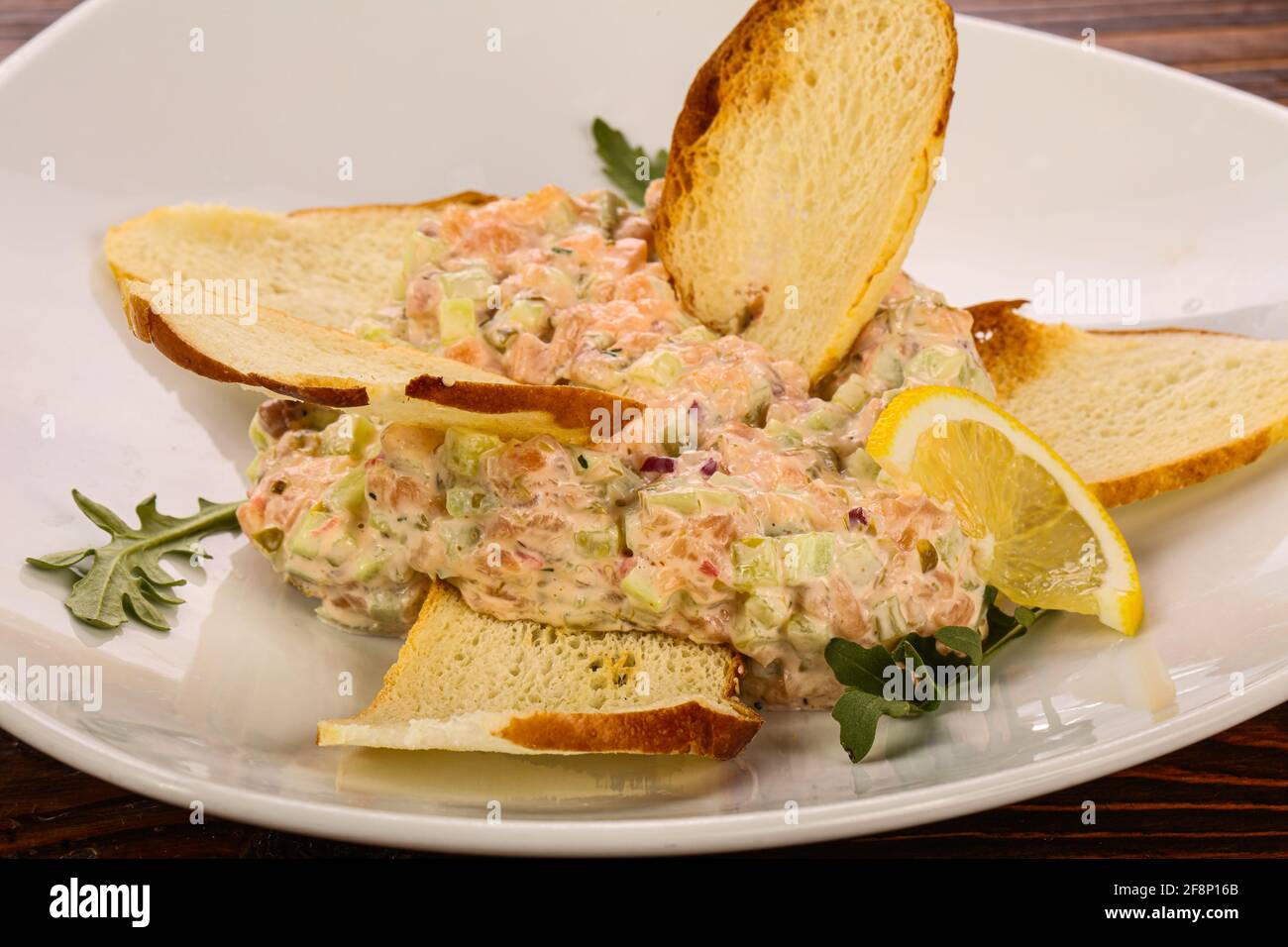 Tartar with salmon fish served lemon slice Stock Photo - Alamy