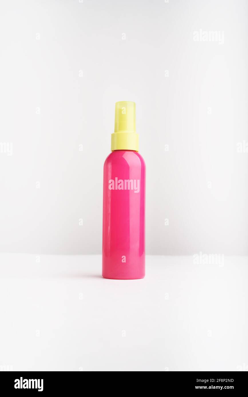 Pink cosmetic bottle with yellow lid on white background Stock Photo ...